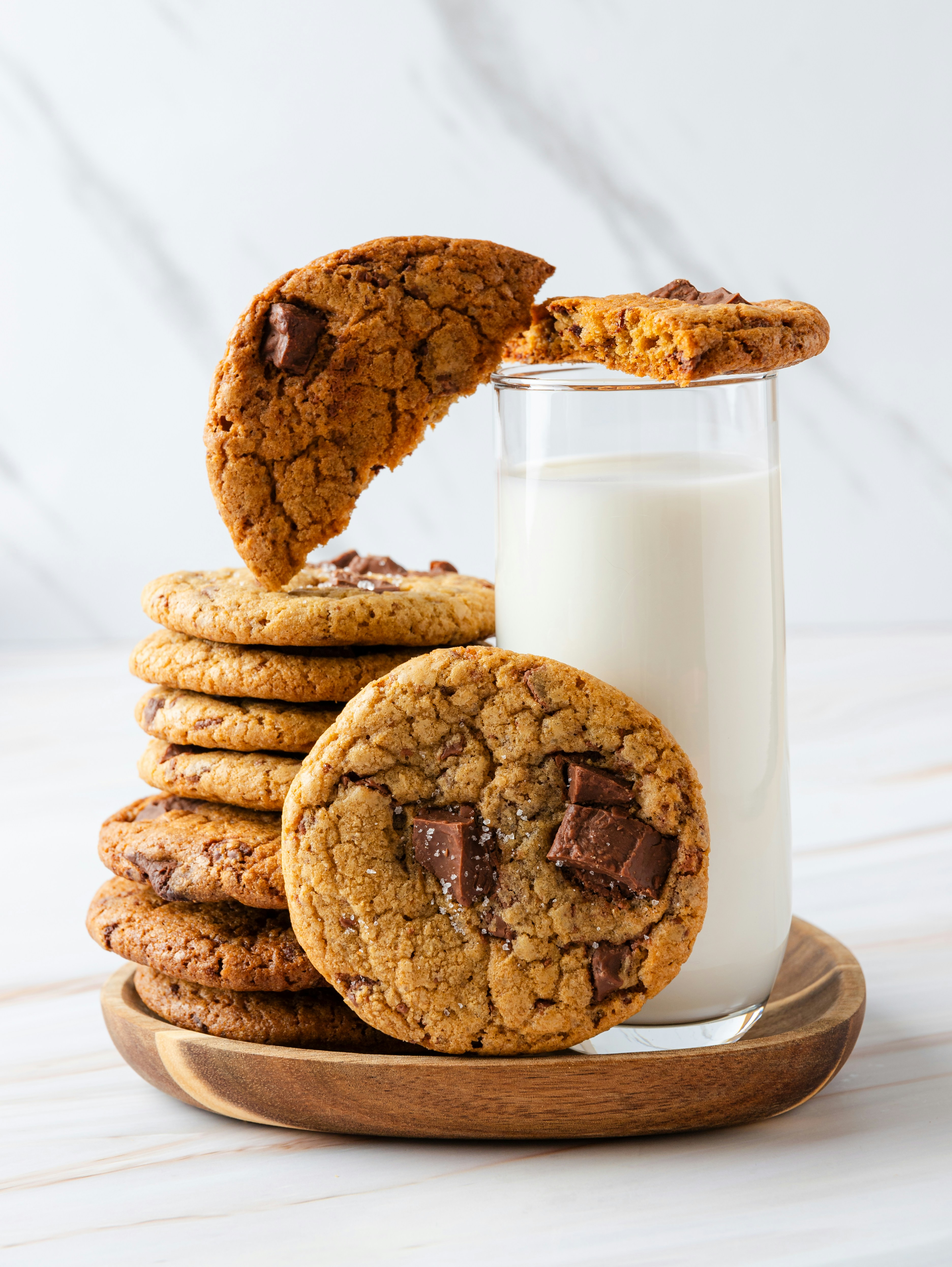 Leaned Cookie Pinnacle: Chocolate Chips Rest Against a Glass of Milk