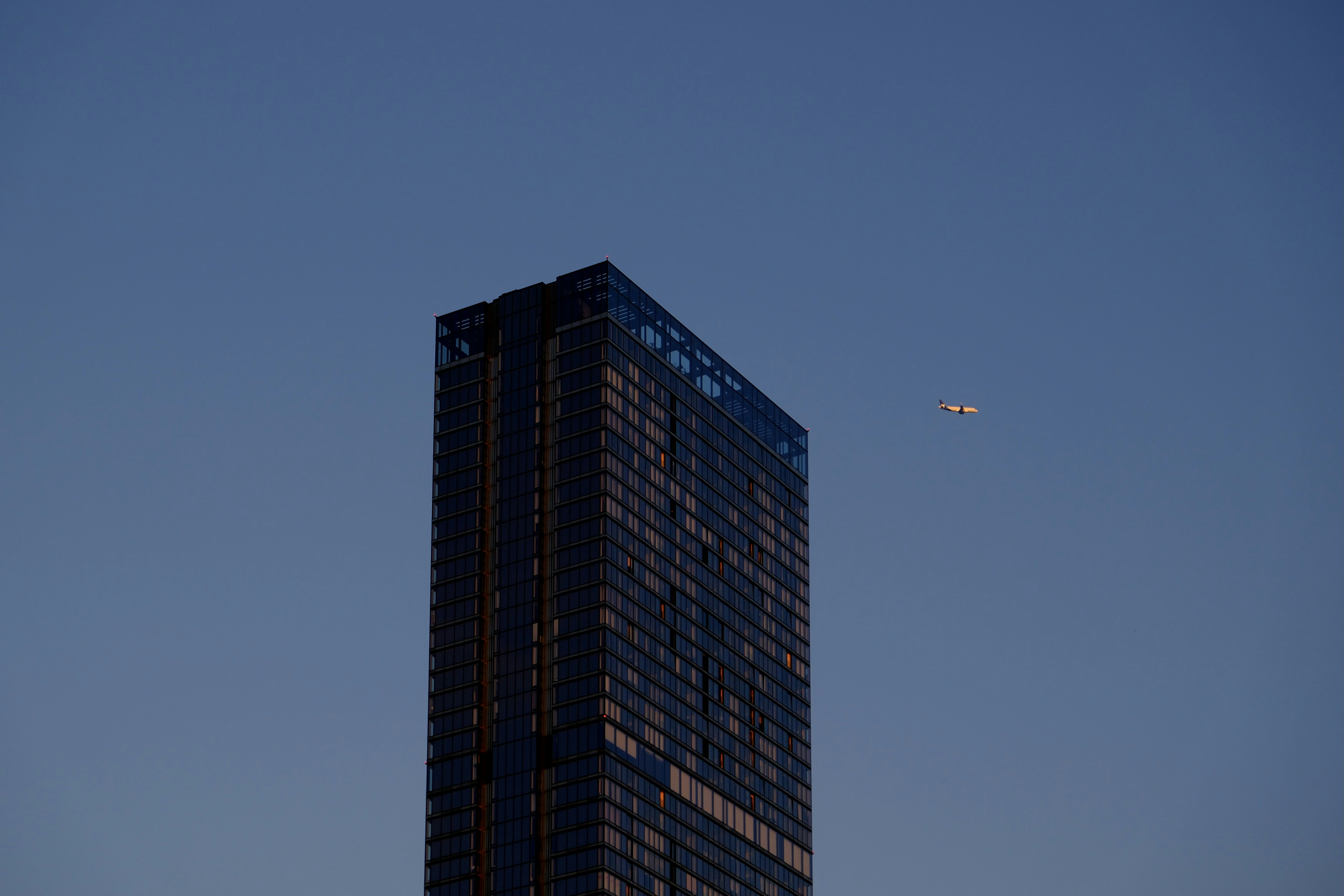 Azure Facade: A Narrow Tower Framing the Open Sky