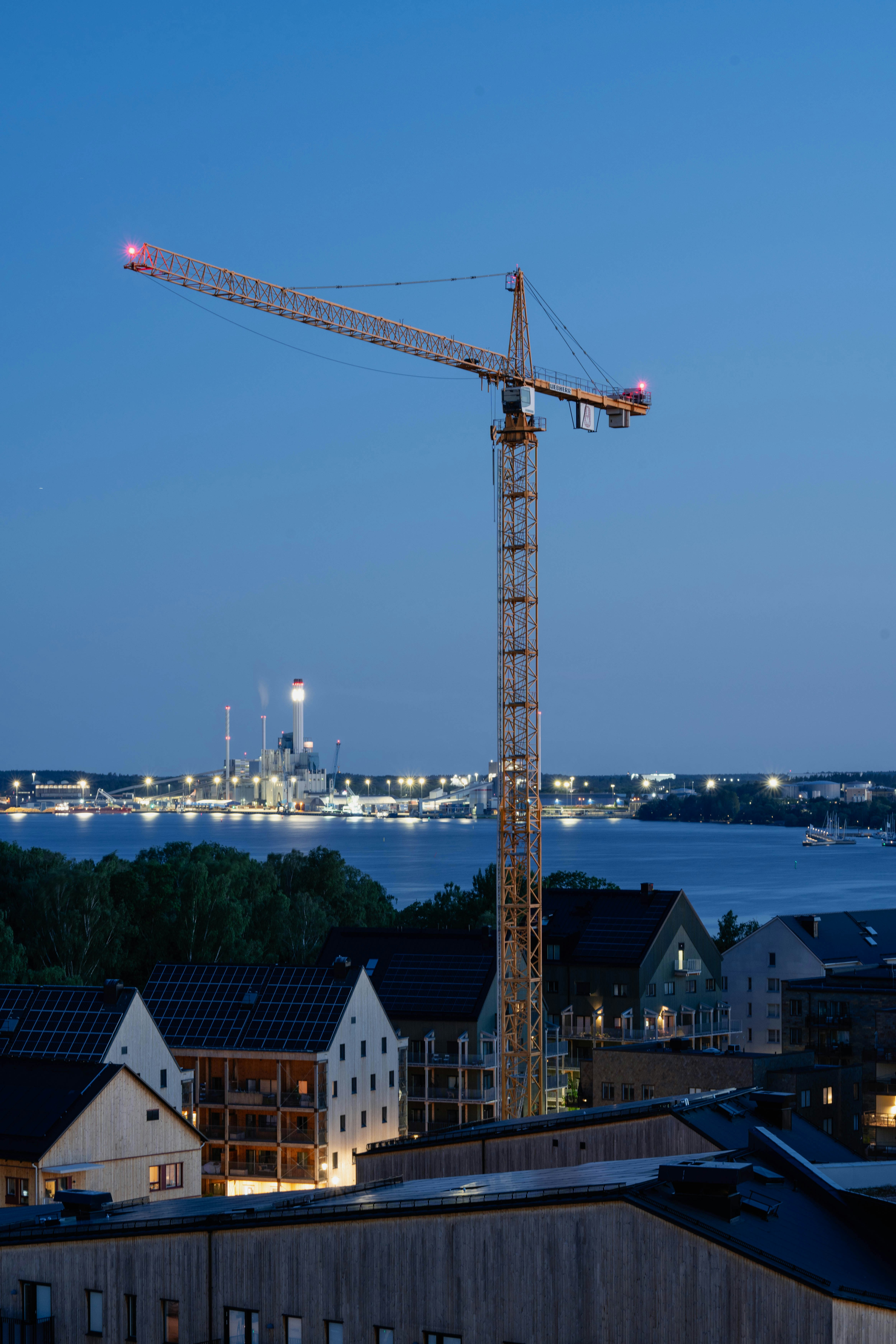 Twilight Crane Over a Quiet Coastal Quarter