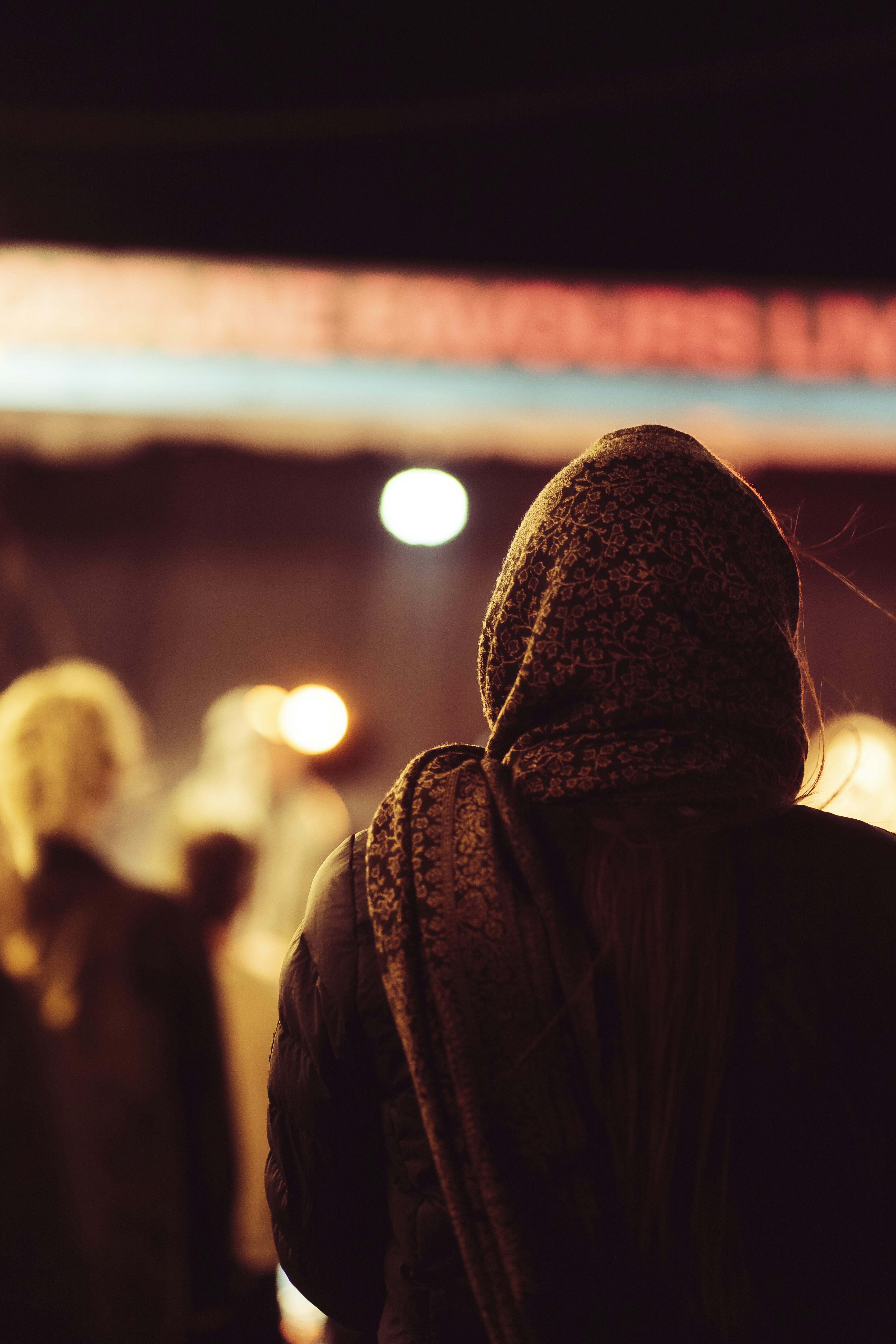 Hooded Figure in Soft Neon Glow