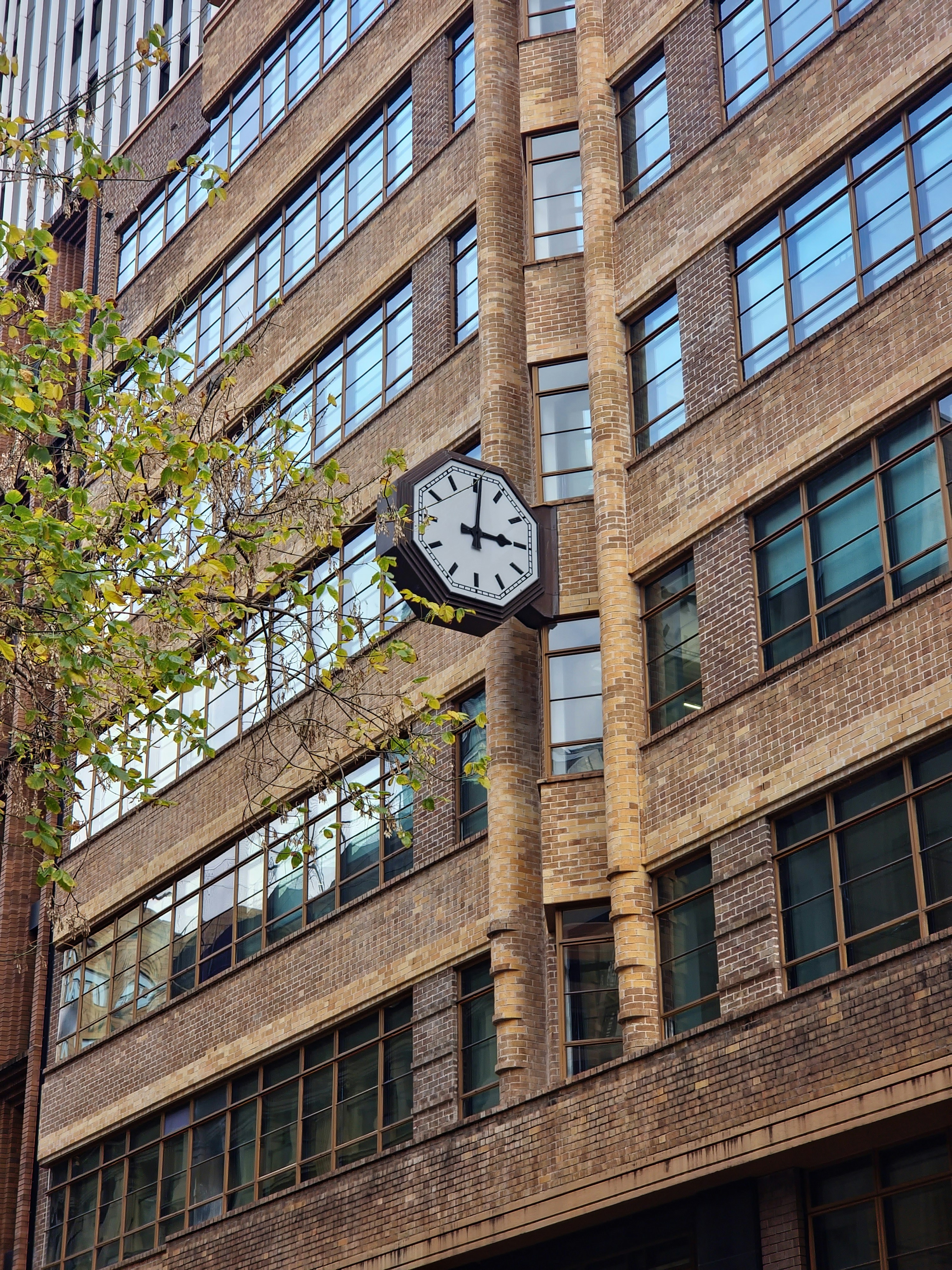 A large building with a clock on the side of it photo – Free Abstract ...