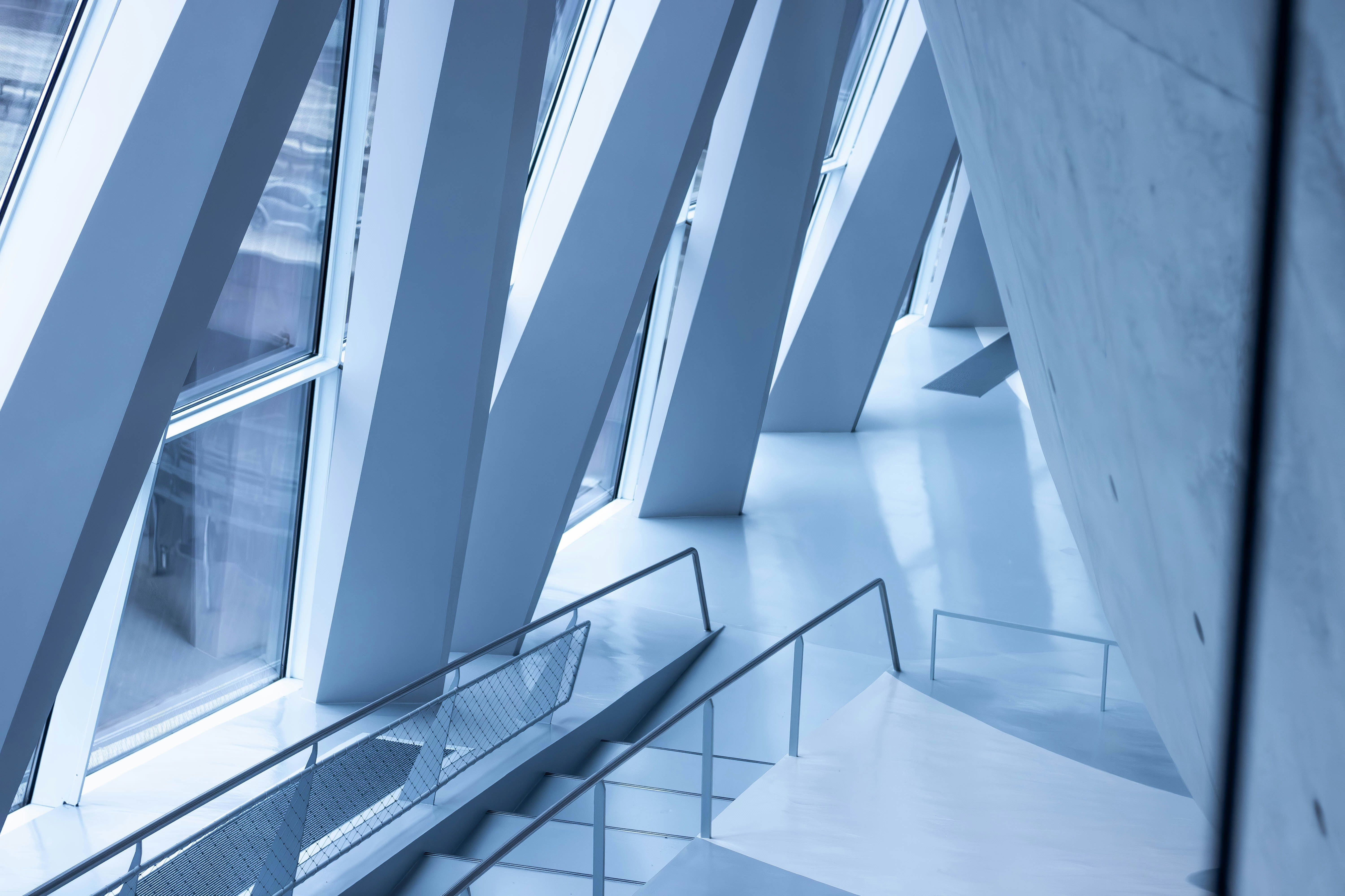 A building that has a bunch of windows in it photo – Free Blue Image on ...