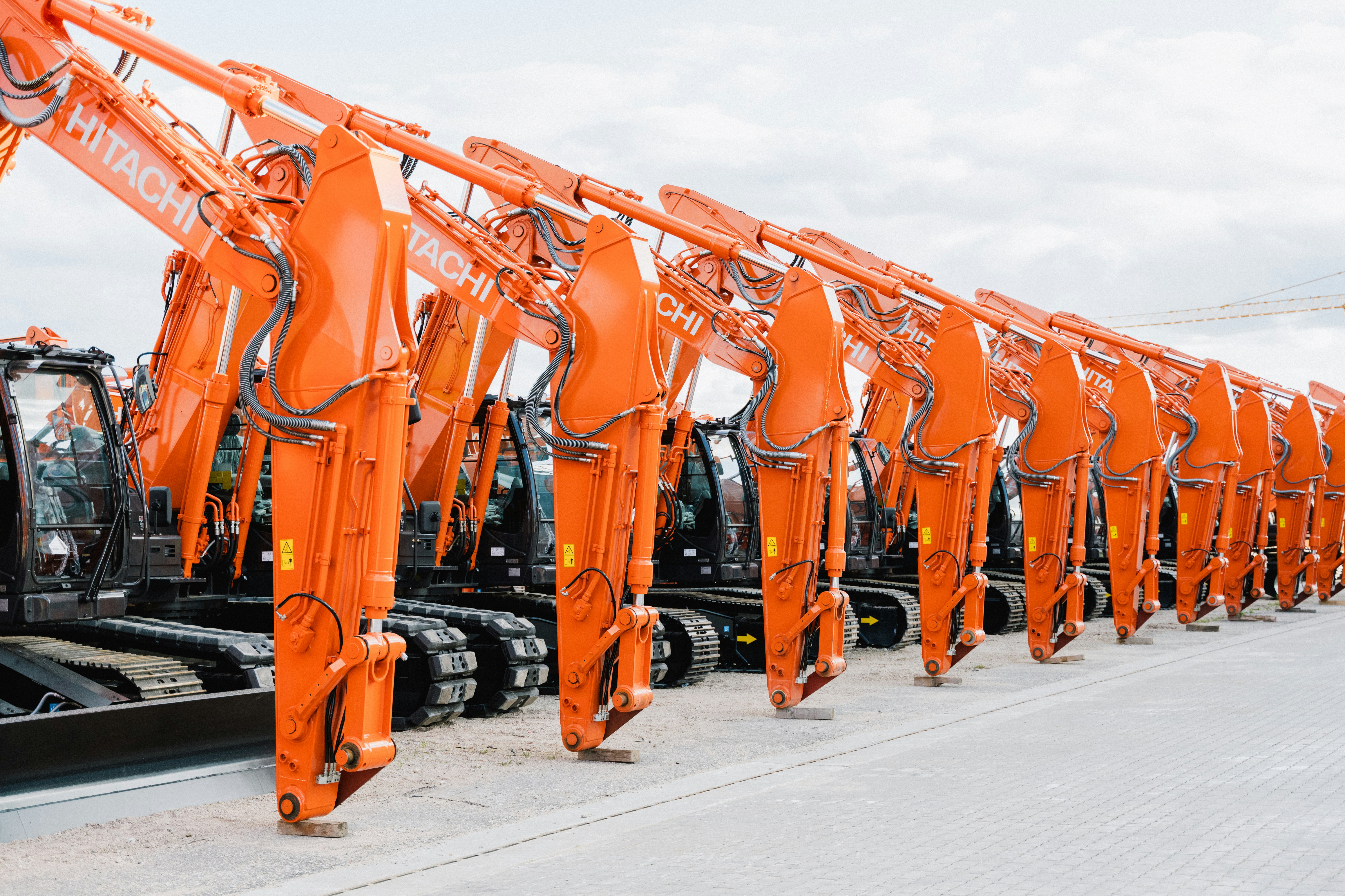 A row of orange machines sitting next to each other photo – Free ...