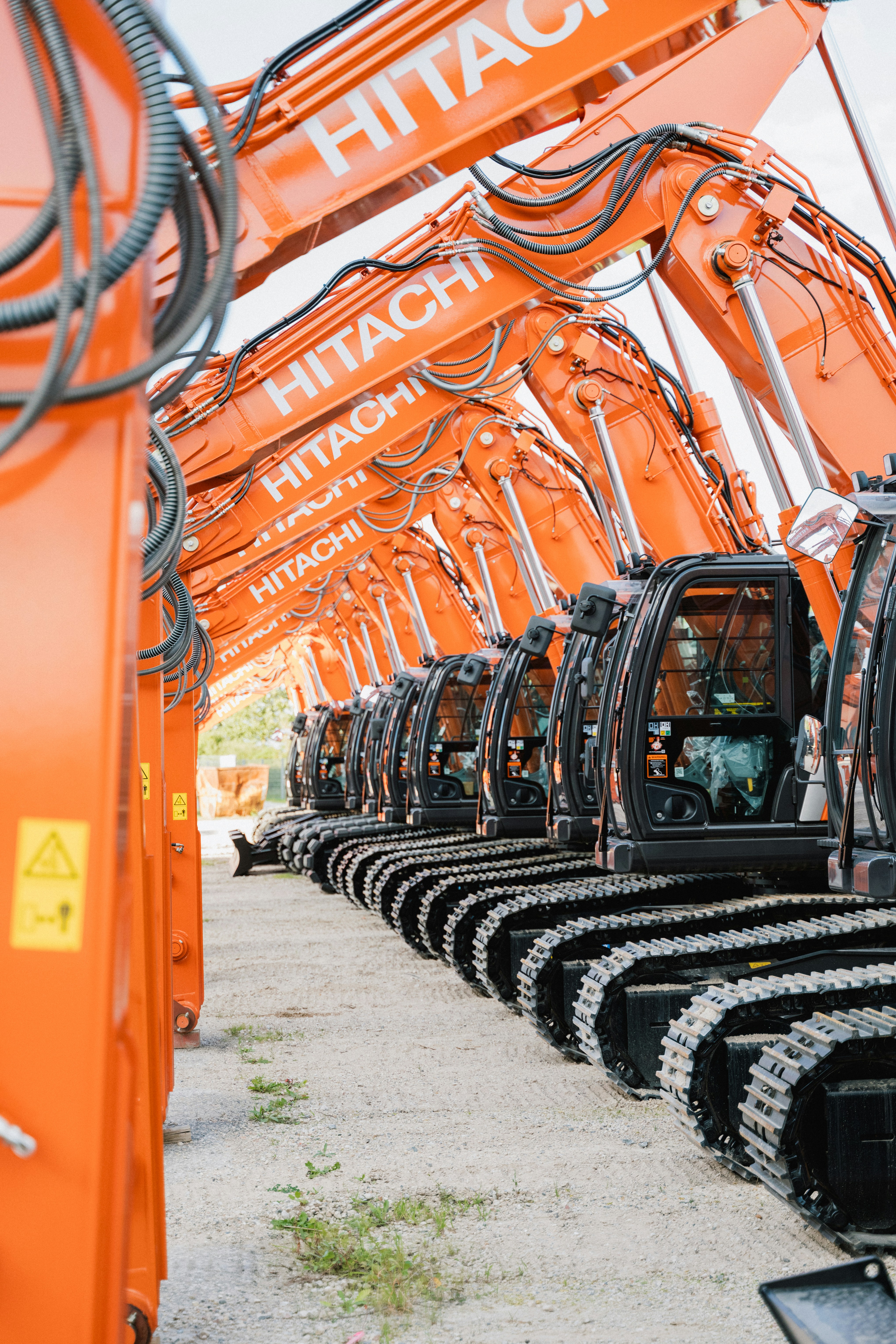 A row of orange machines sitting next to each other photo – Free Coreum ...