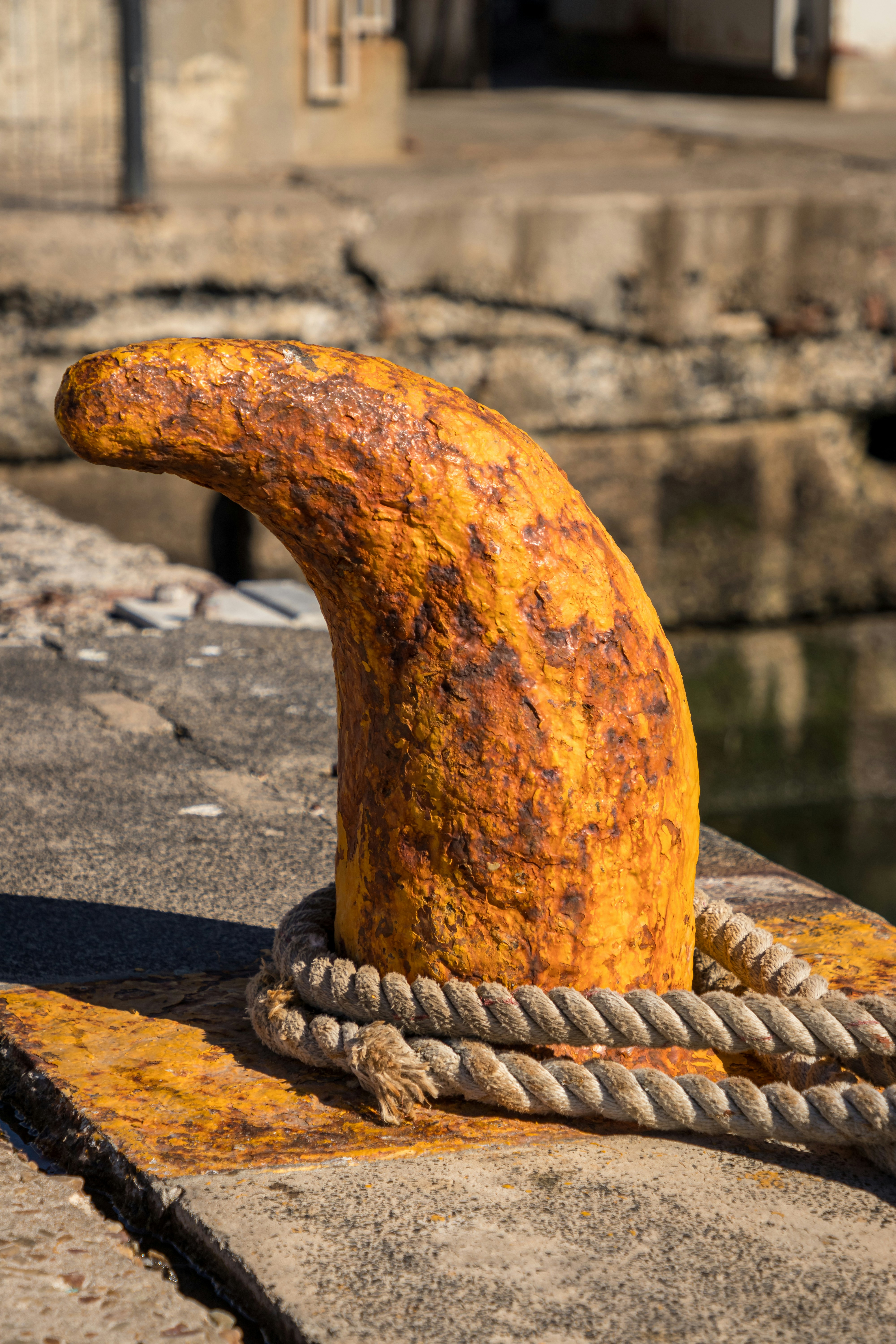 A rusted rope on the ground next to a body of water photo – Free Cape ...