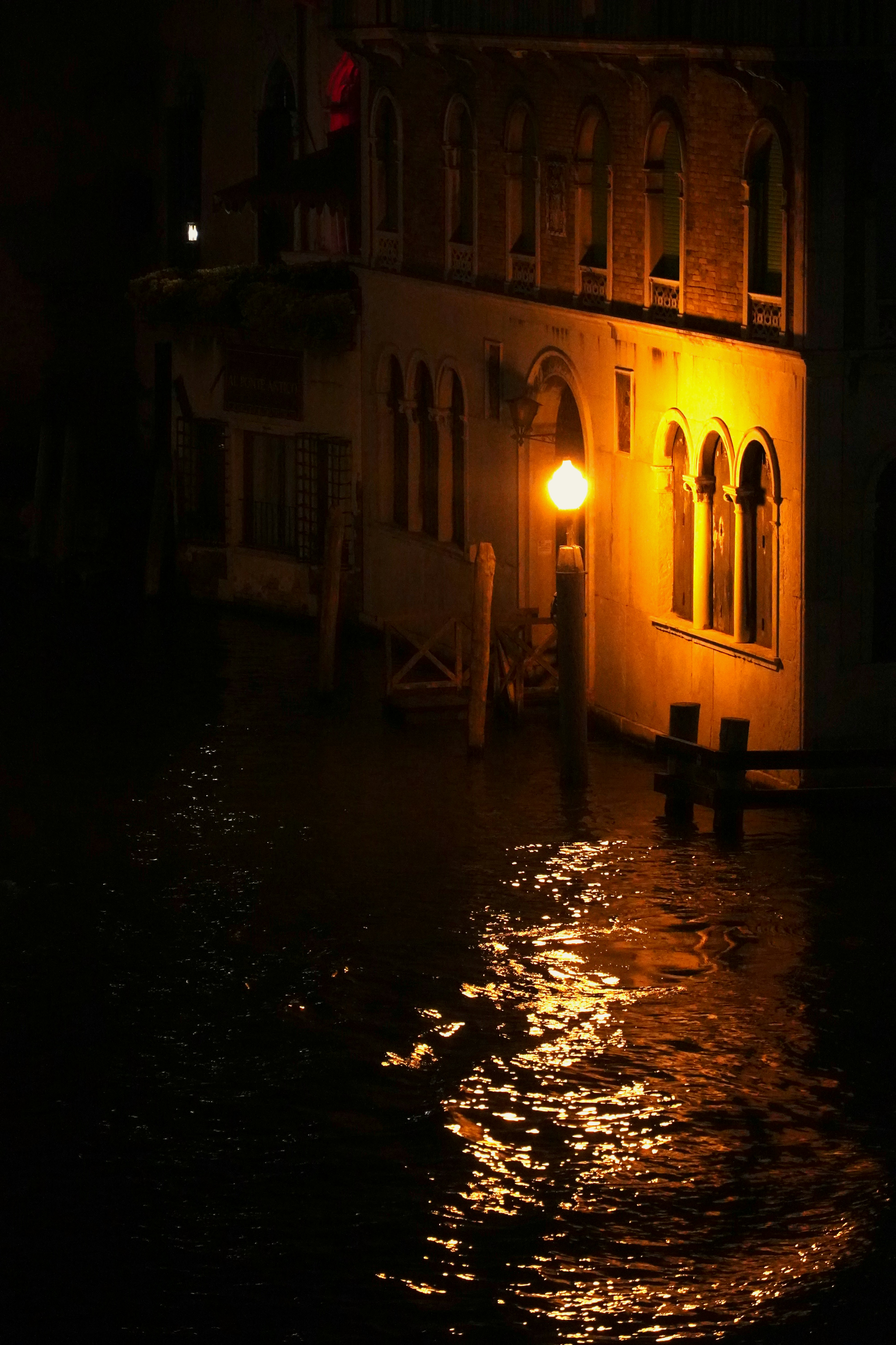A flooded street at night with a street light photo – Free Venice Image ...