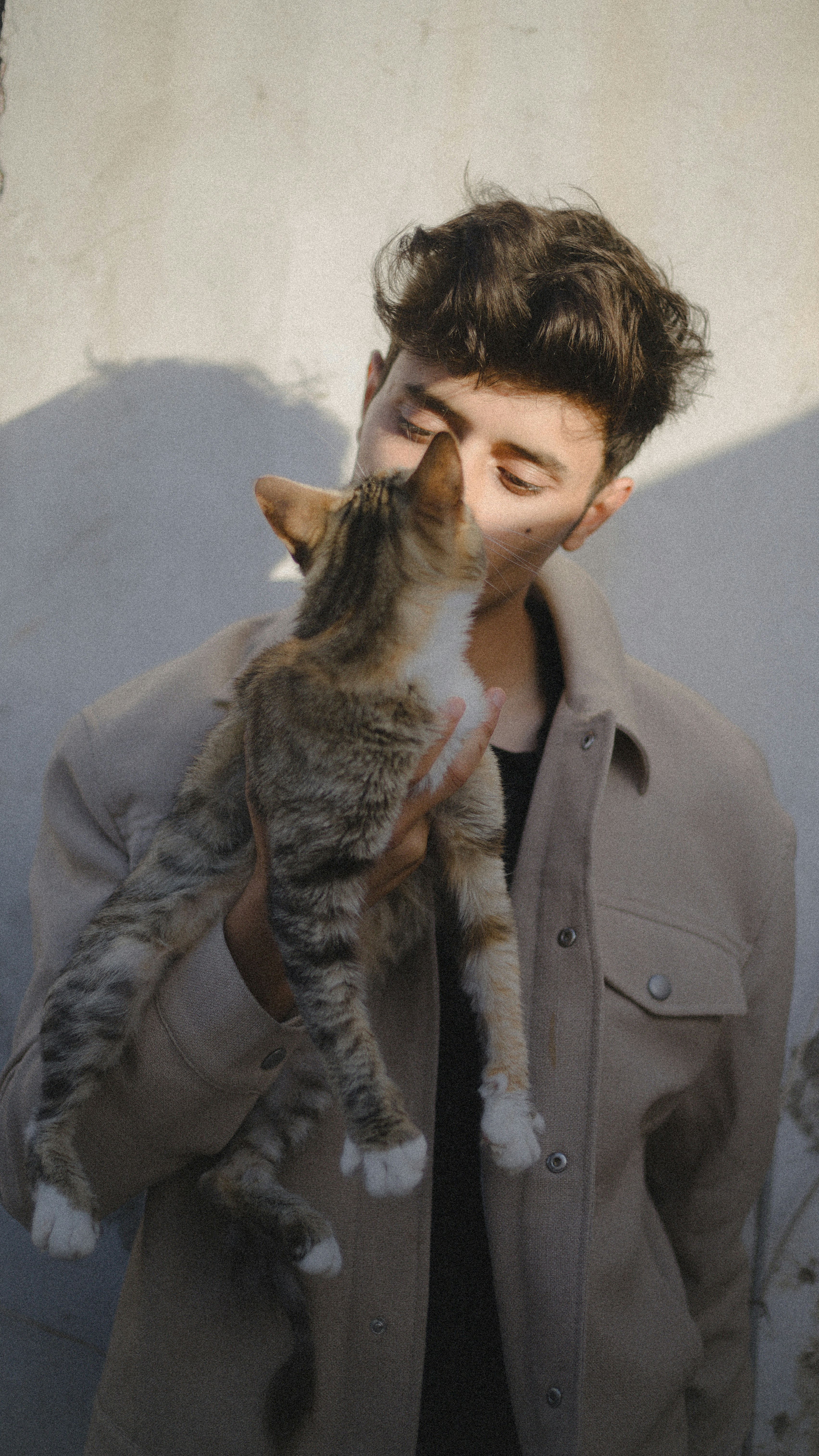 Whiskered Kiss: A Quiet Moment Between Man and Cat