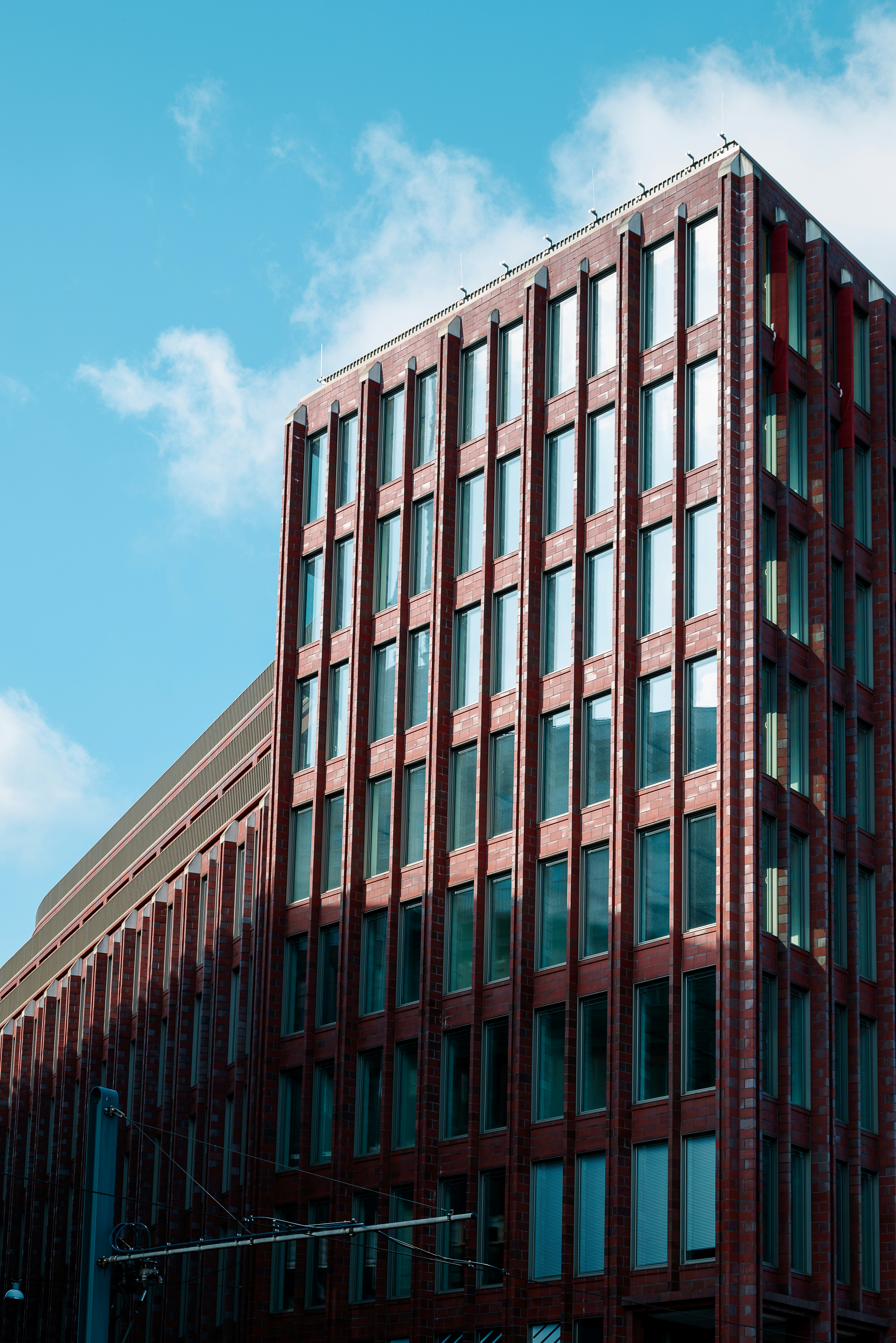 Un edificio rojo alto con muchas ventanas foto – Imagen de Urbano ...