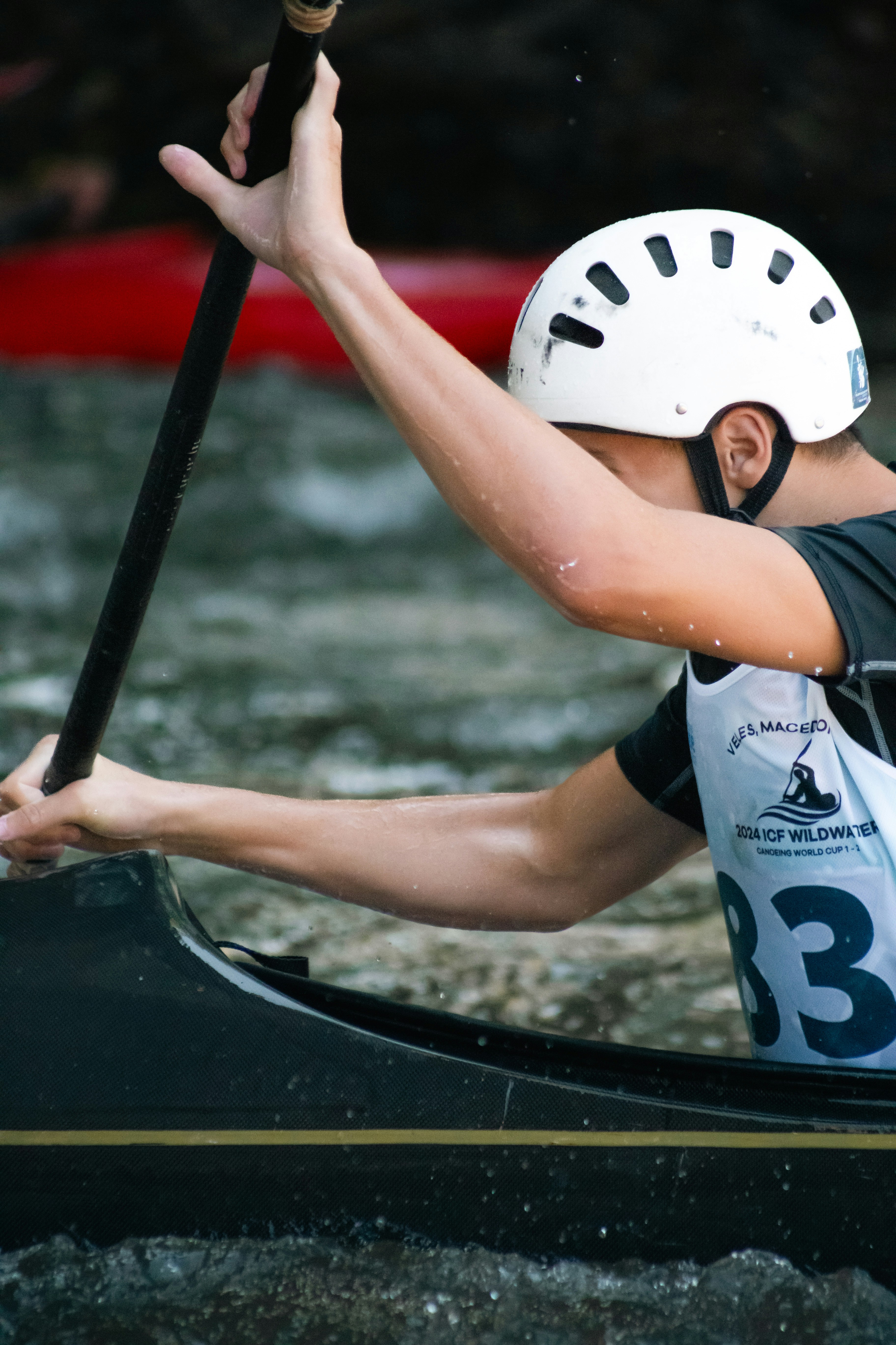 Rower in Rapid Water: Focused Power Amid the Oar Stroke