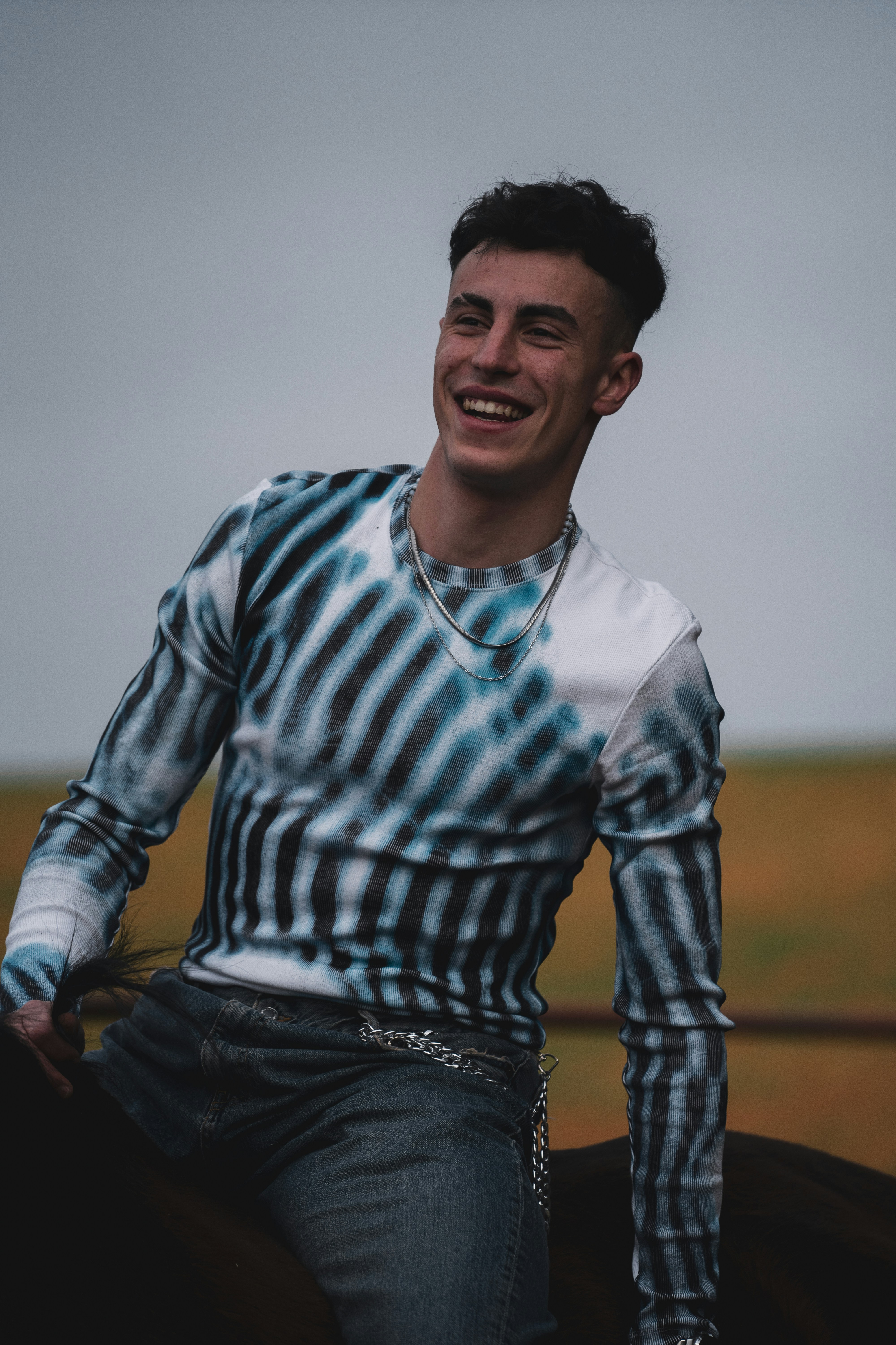 Laughing on the Reins: A Tie-Dye Moment in the Open Field