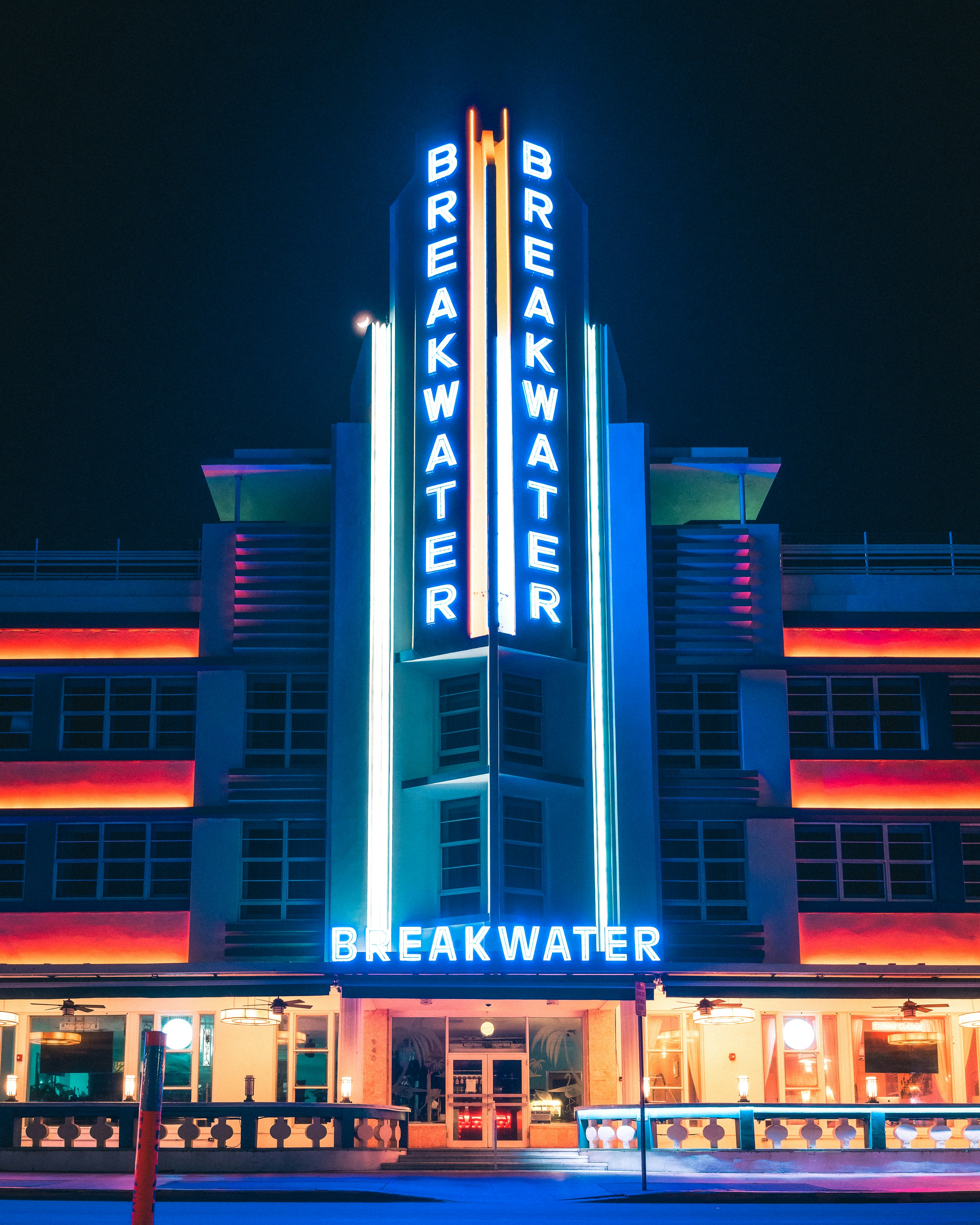 A large building with a neon sign on it's side photo – Free Miami beach ...