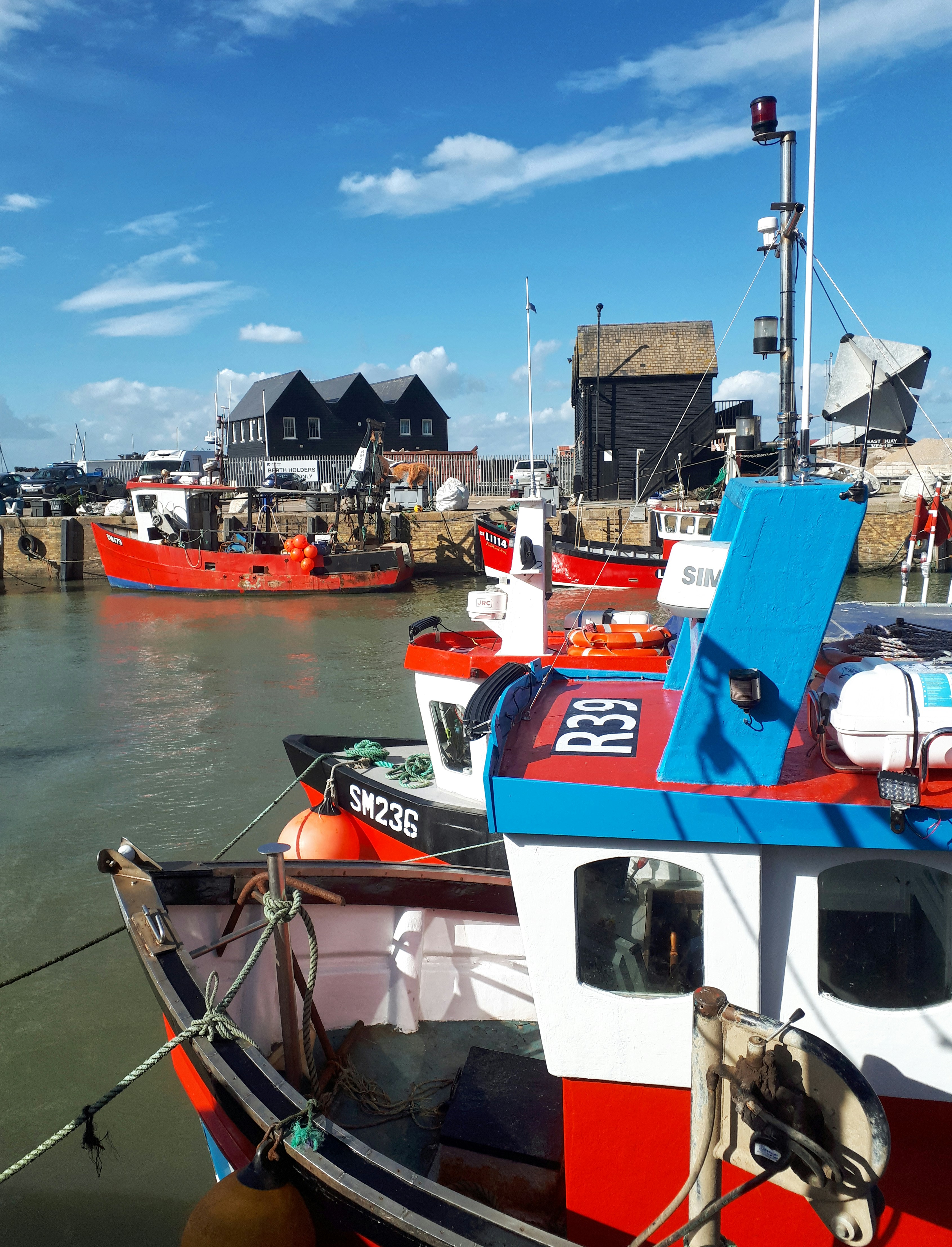 A number of boats in a body of water photo – Free Whitstable harbour ...