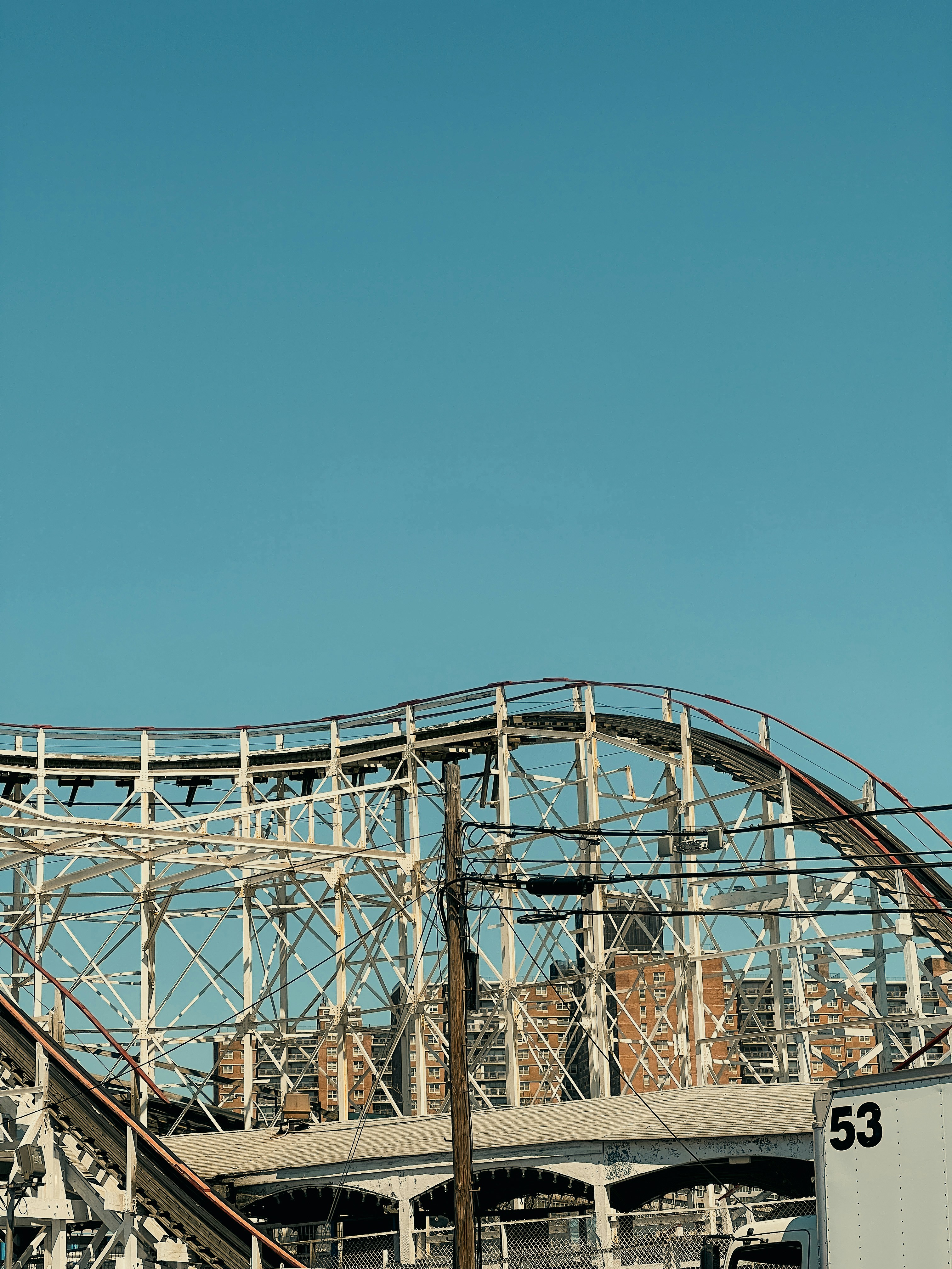 A roller coaster going down a hill on a clear day photo – Free Beach ...