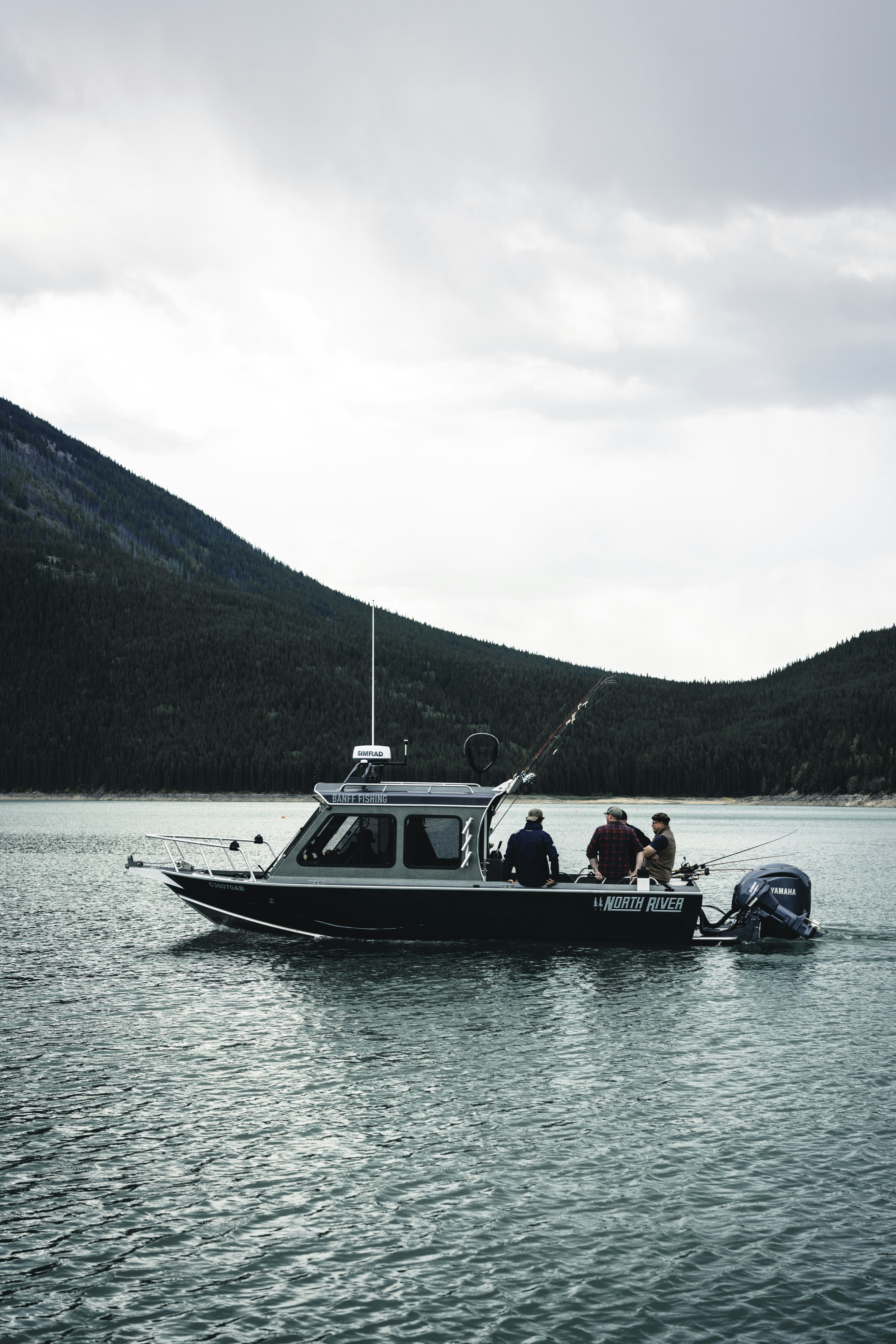 Seafarers on a Quiet Lake: Boat at Rest Amid Immense Pines