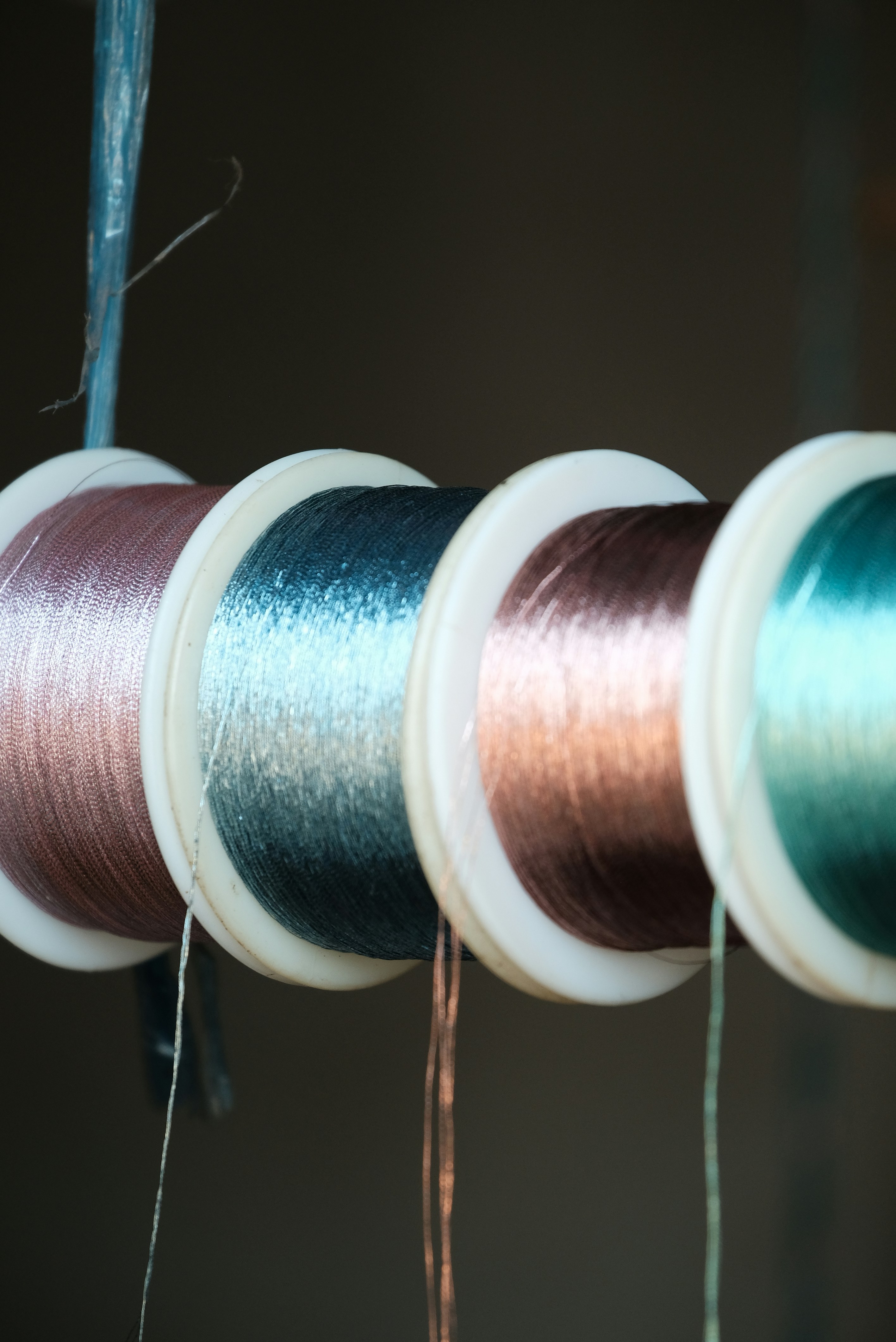 Pastel Spools: A Close-Up Study of Ribboned Threads