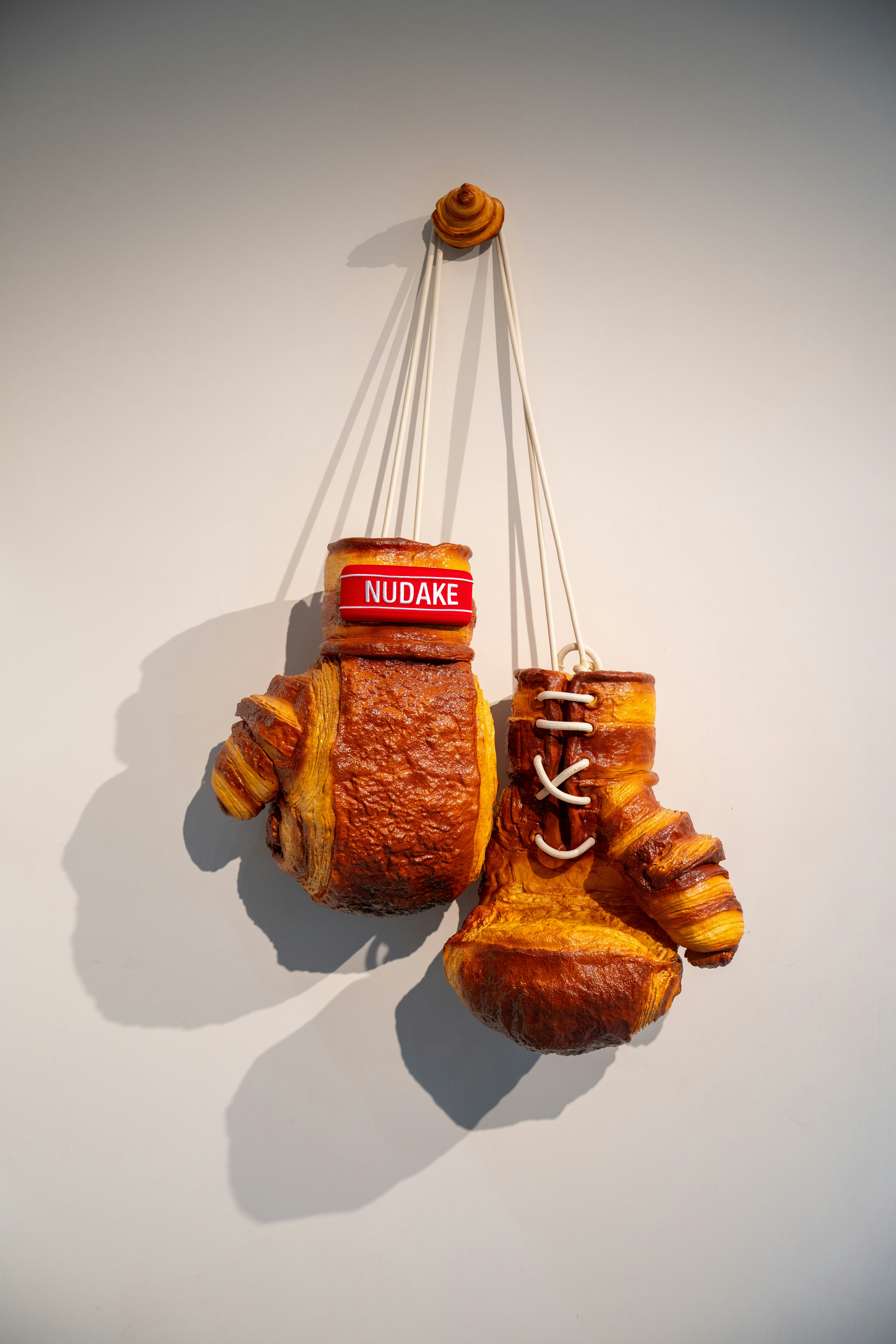 Crustbound Duo: A Hanging Bakery Sculpture of Glove and Boot