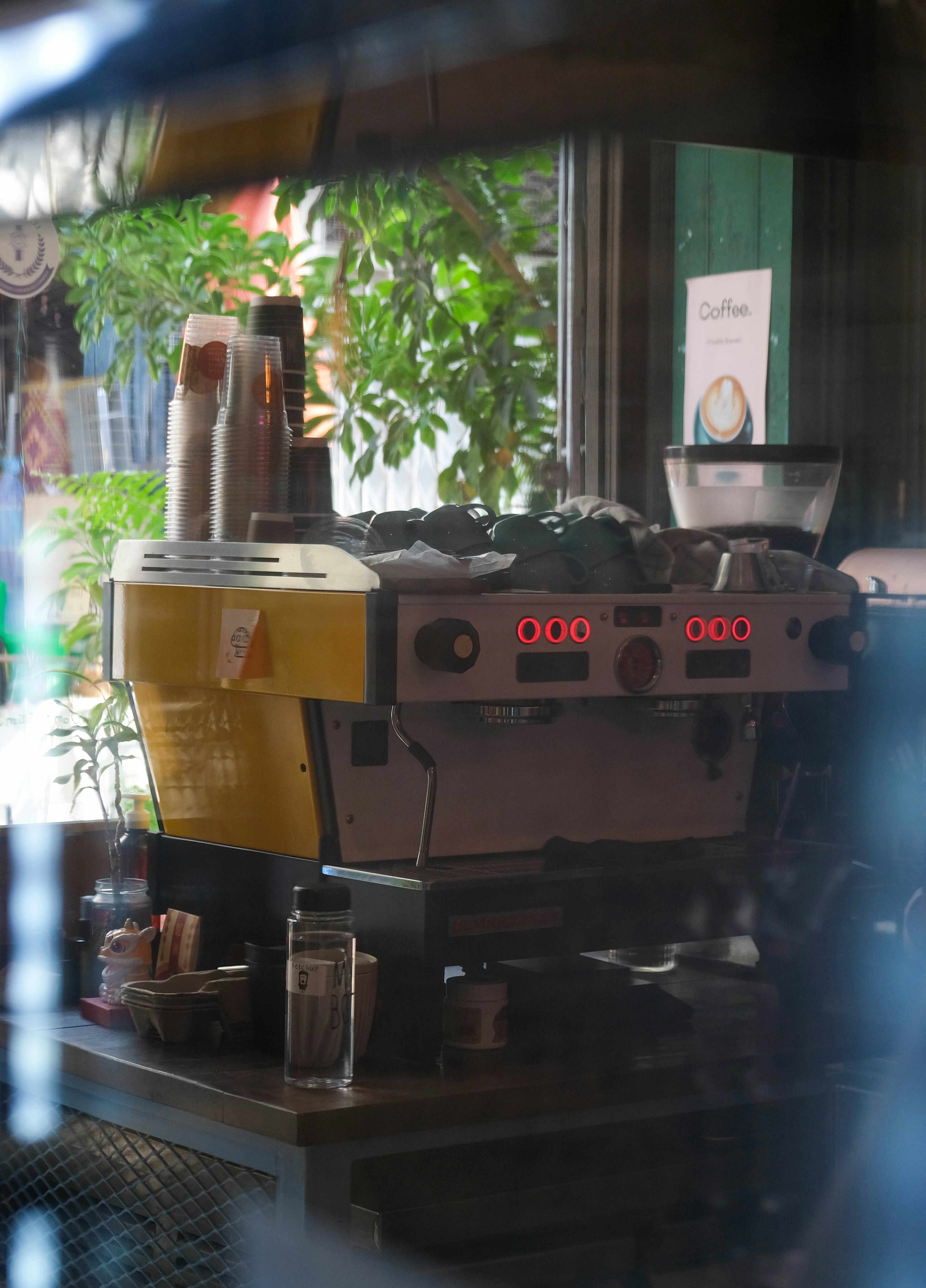 Red-Dial Espresso Station Framed by Glass and Greenery