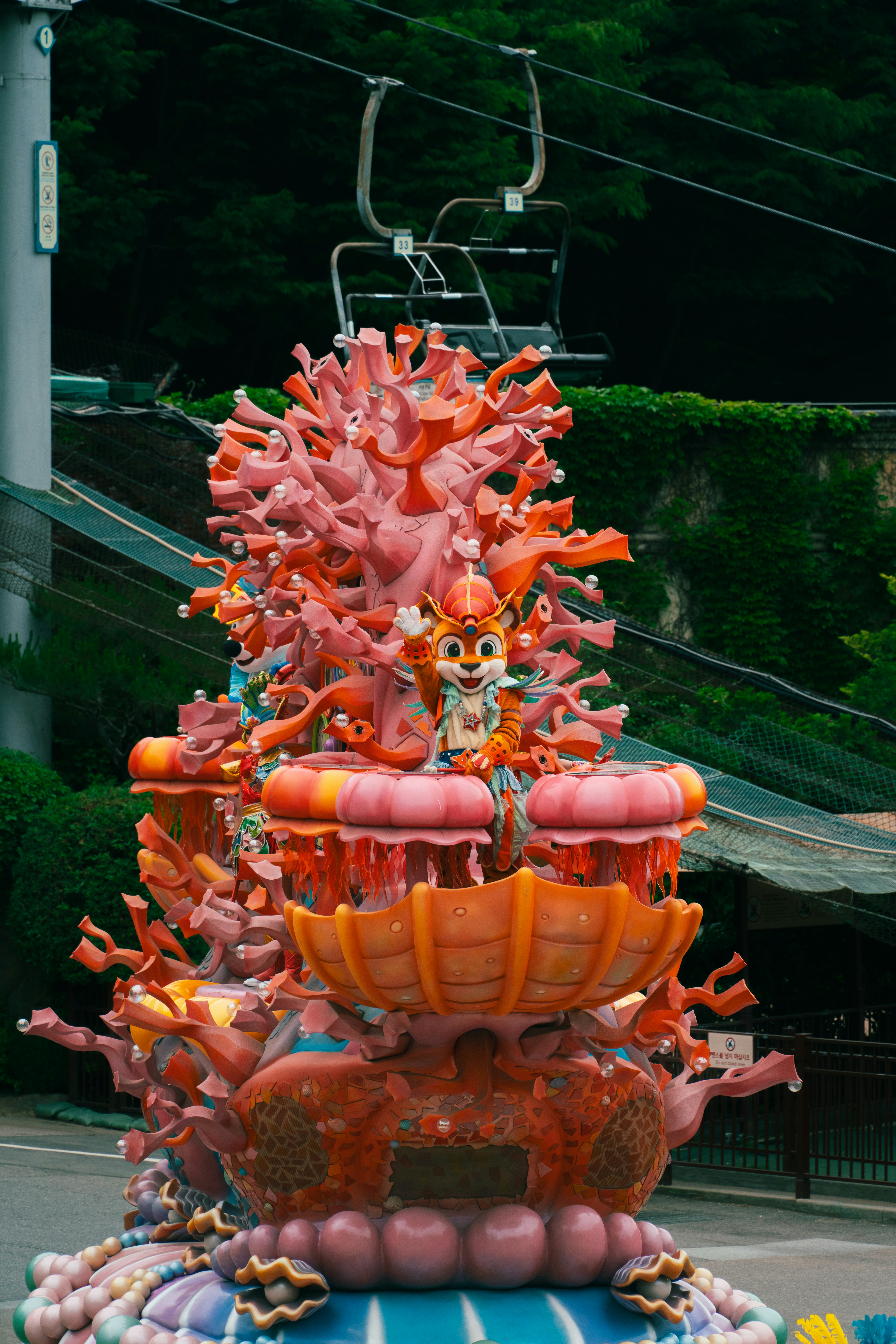 Flaming Coral Dragon Sculpture with Tiger Figure Under the Chairlift