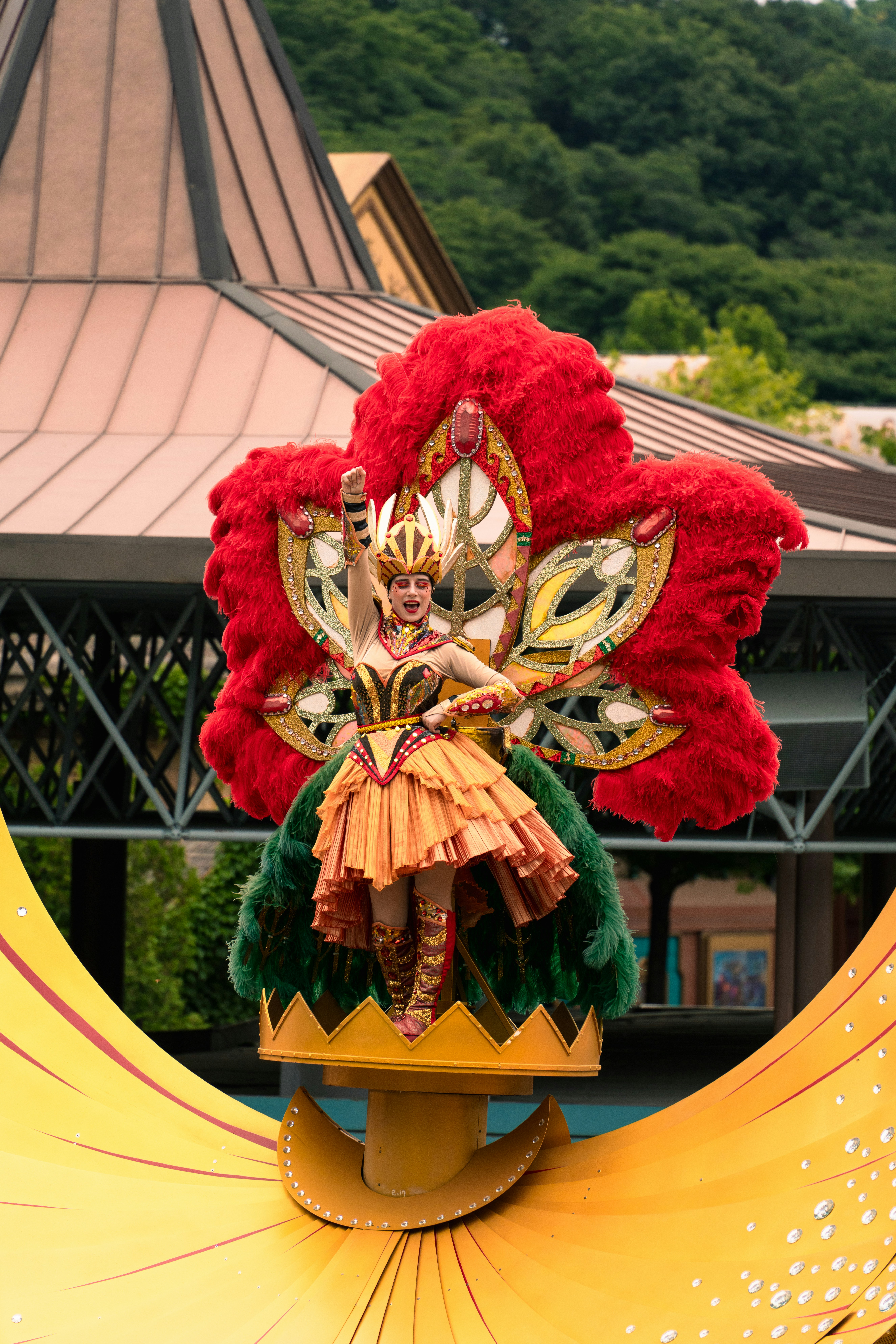 Red Bloom on a Golden Crescent: Carnival Dancer with Feathered Wings