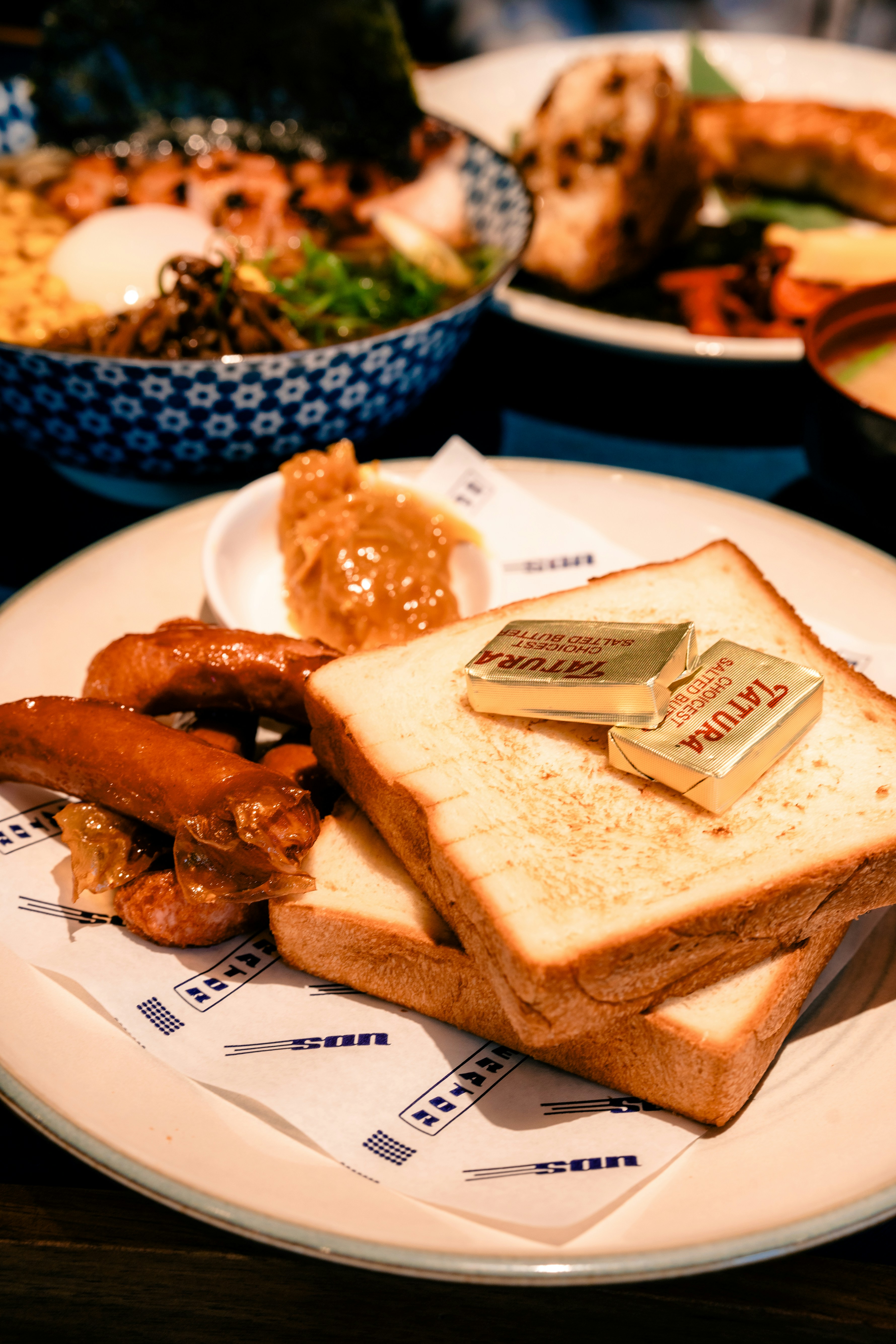 Toasted Sandwich with Buttered Butter Packets on a Plate of Rationed Delights