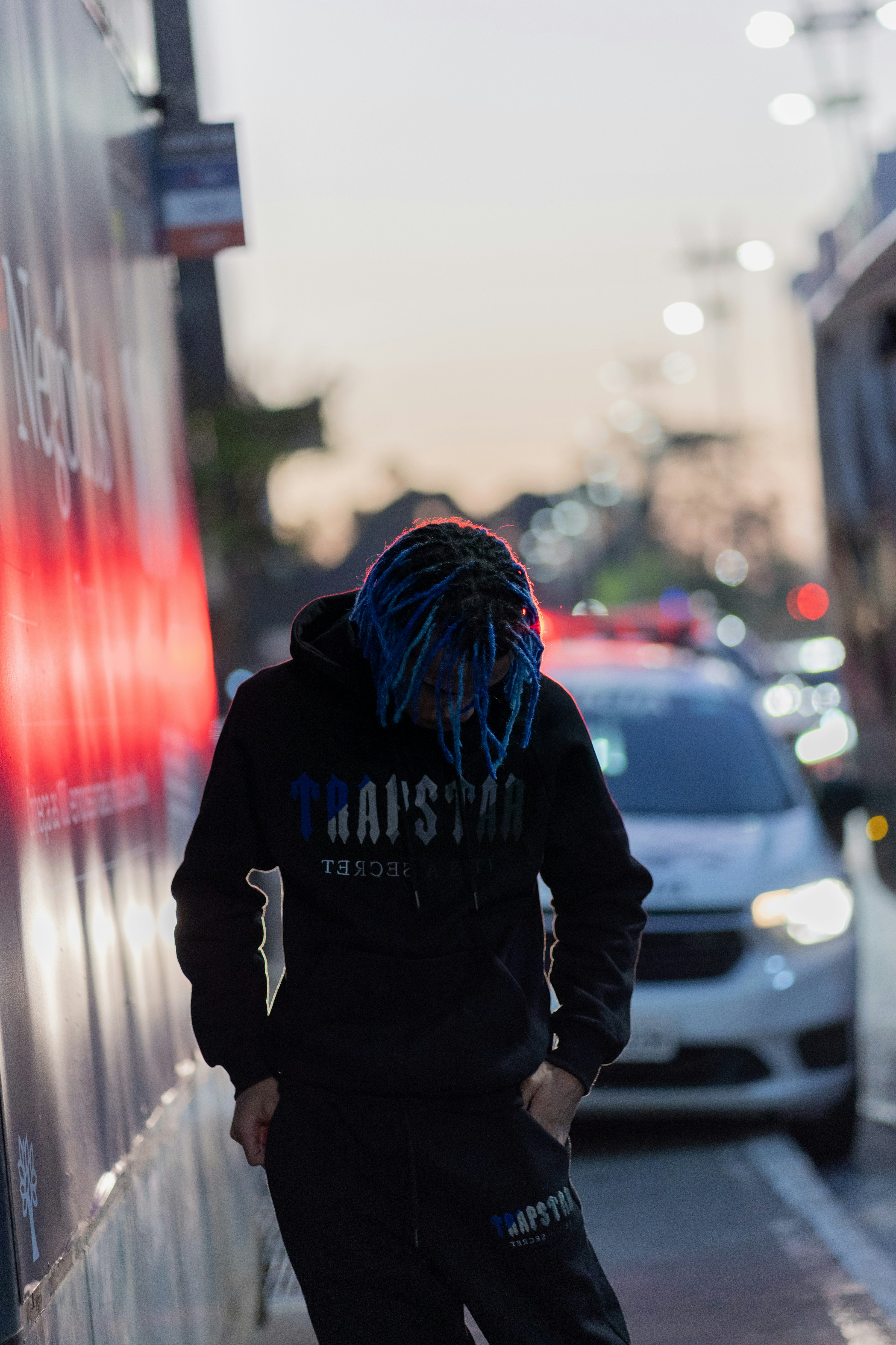 Blue Hair, Red Sirens: Street Portrait at Dusk
