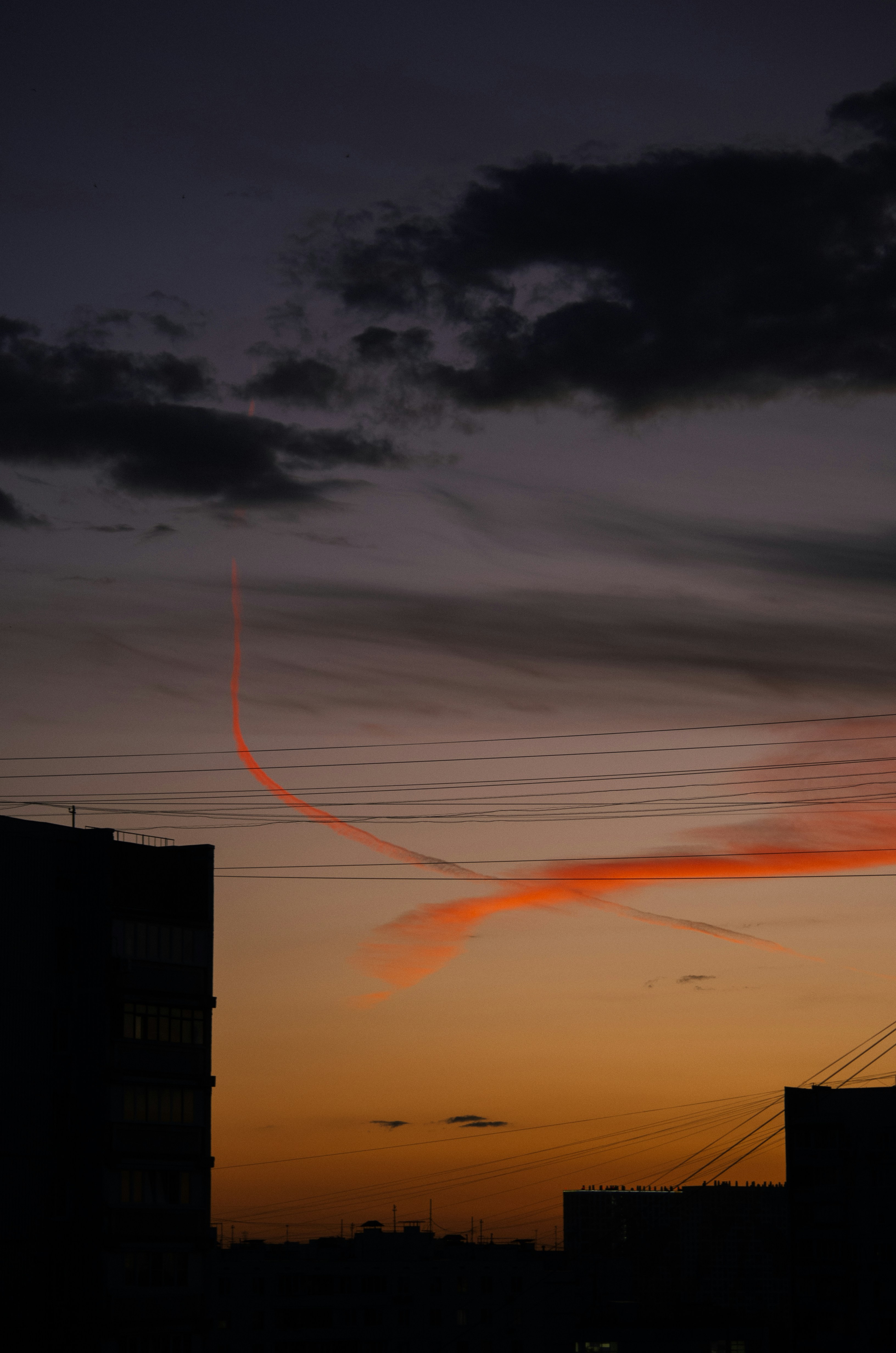 Crimson Ribbon over a Quiet Sunset City