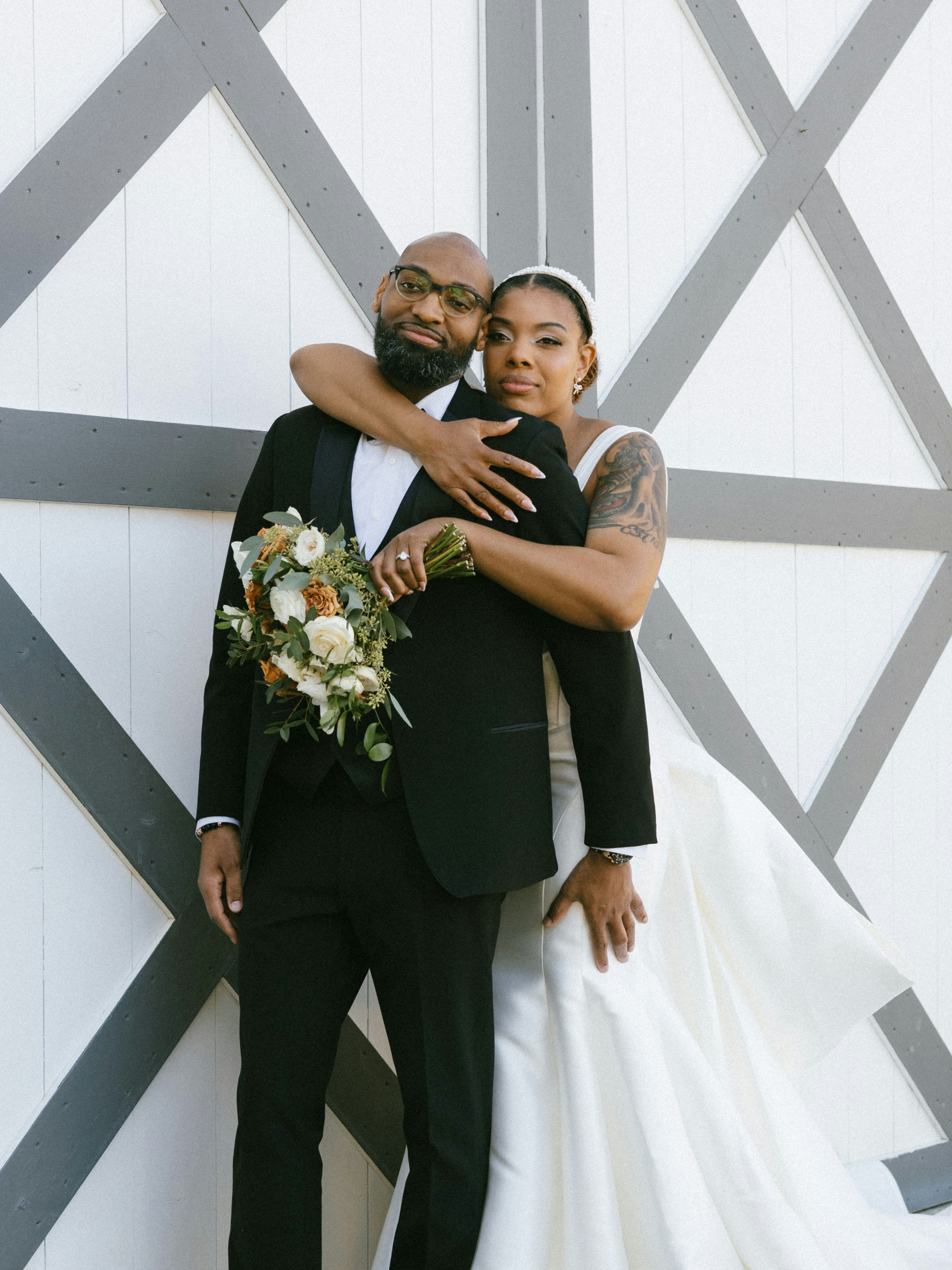 A bride and groom posing for a picture in front of a wall photo – Free ...