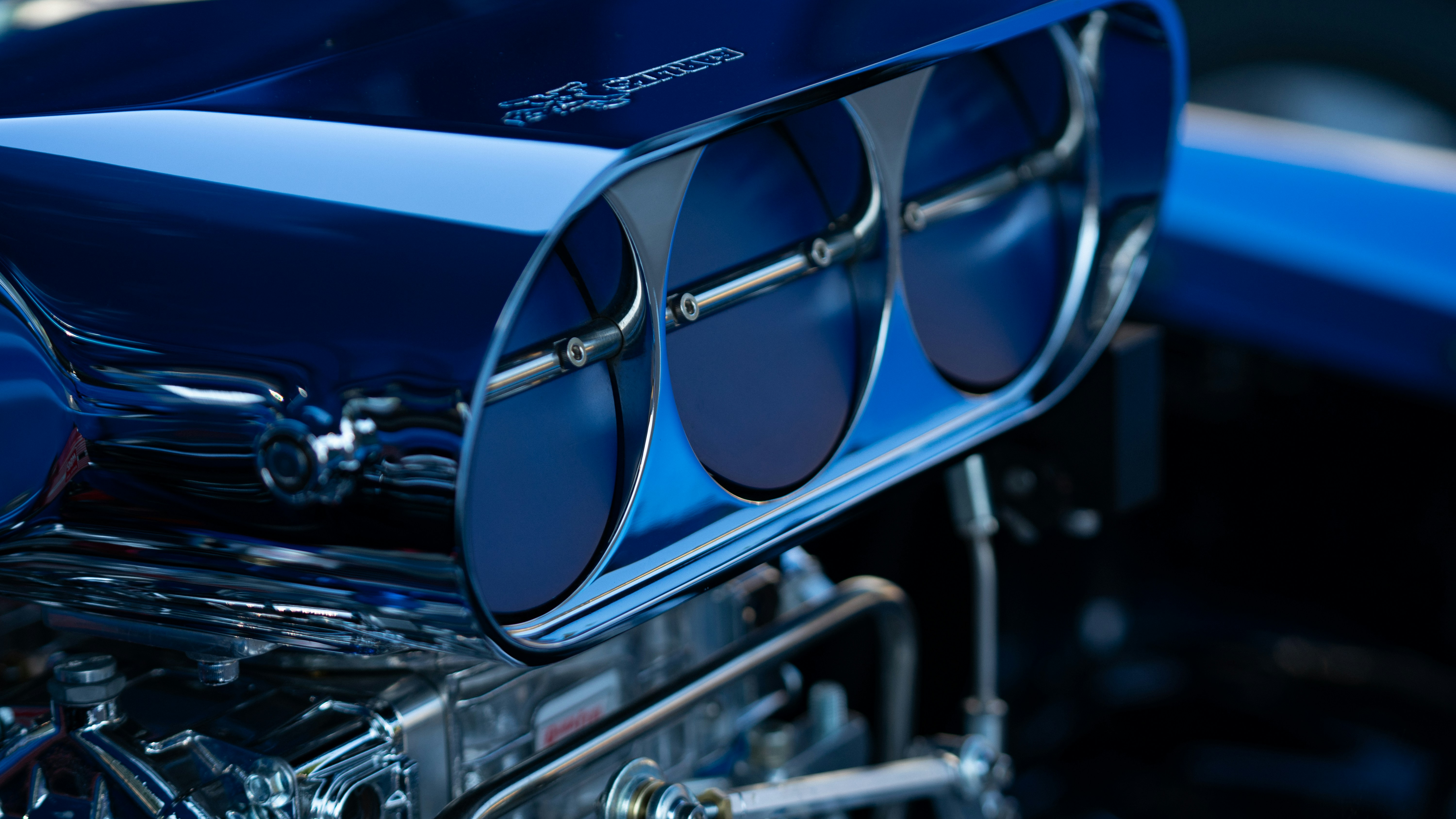 Blue Front-End in Focus: Quad Circular Grilles and Exposed Engine Detail