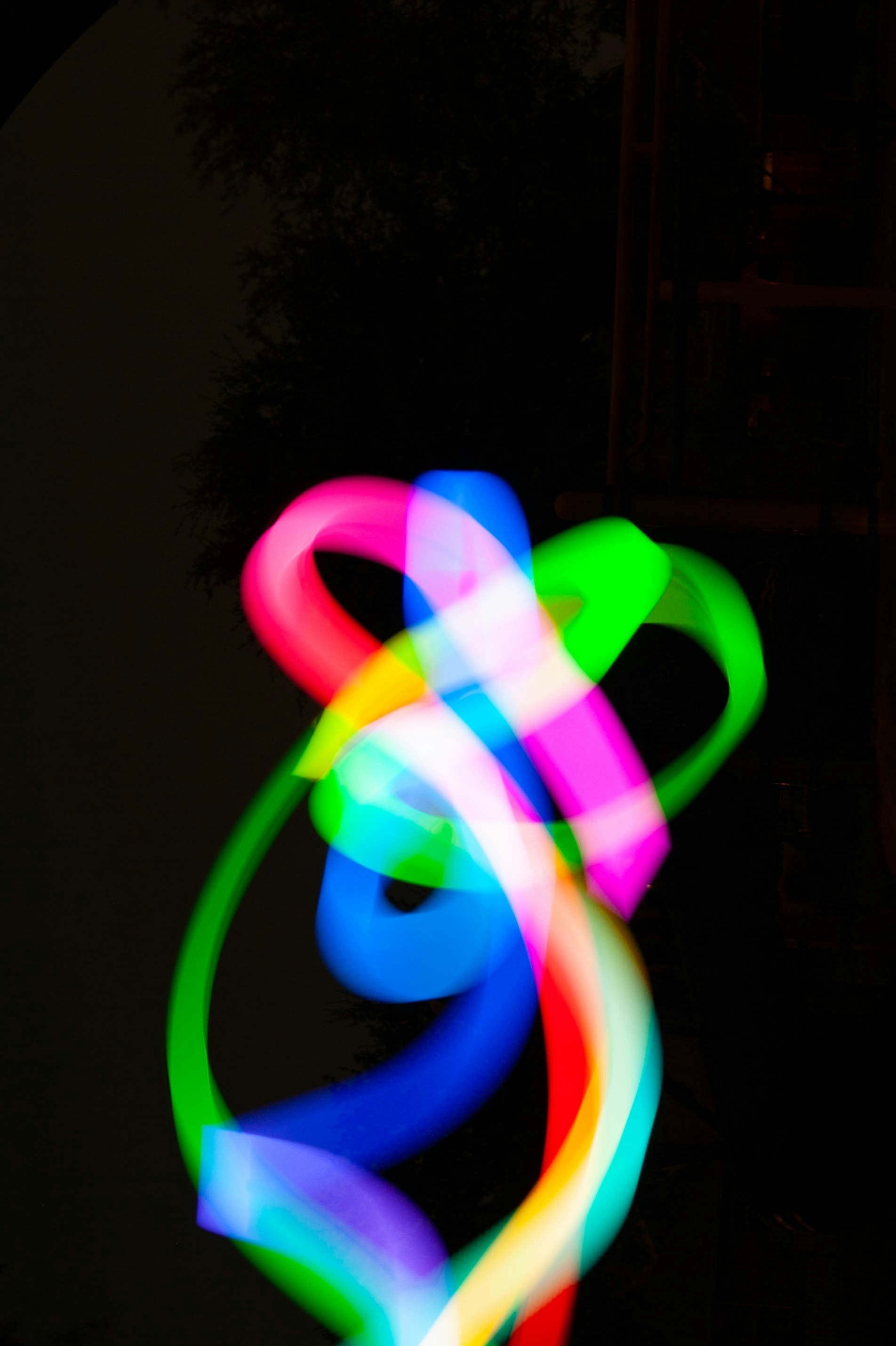 A blurry photo of a colorful object in the dark photo – Free Abstract ...