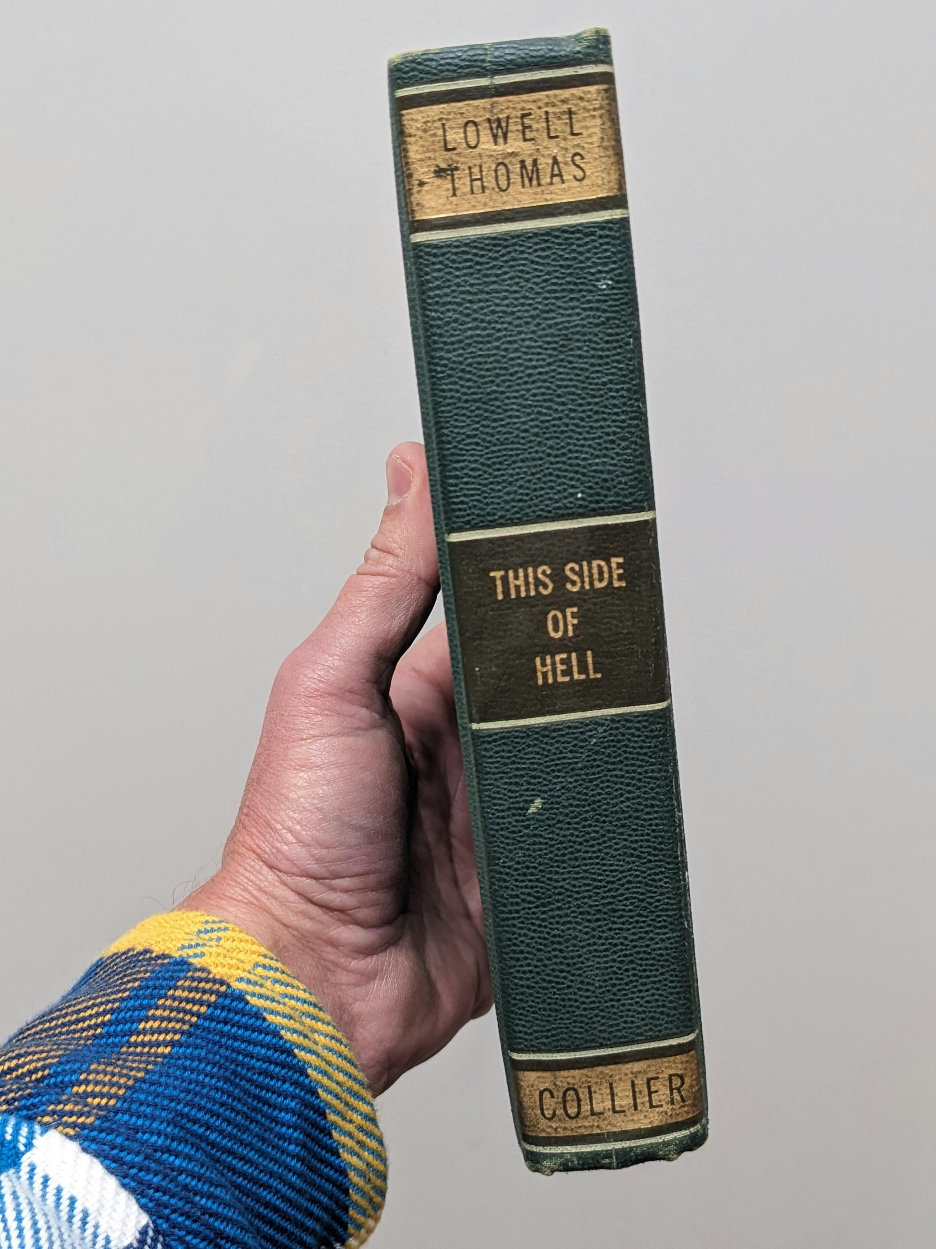 Hand holding a book with an intriguing title