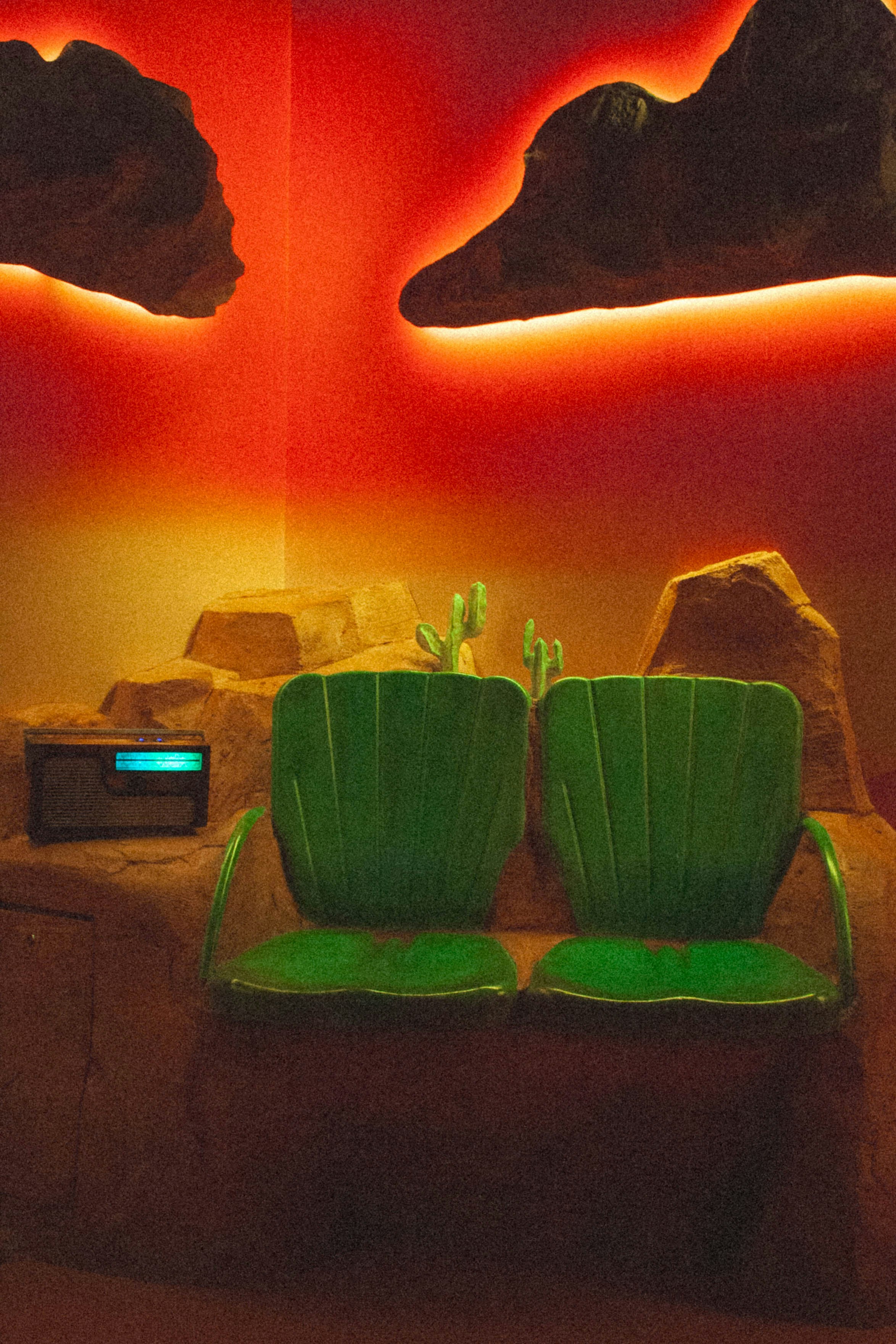 Deserted Lounge: Green Seats Beneath a Lava Sunset