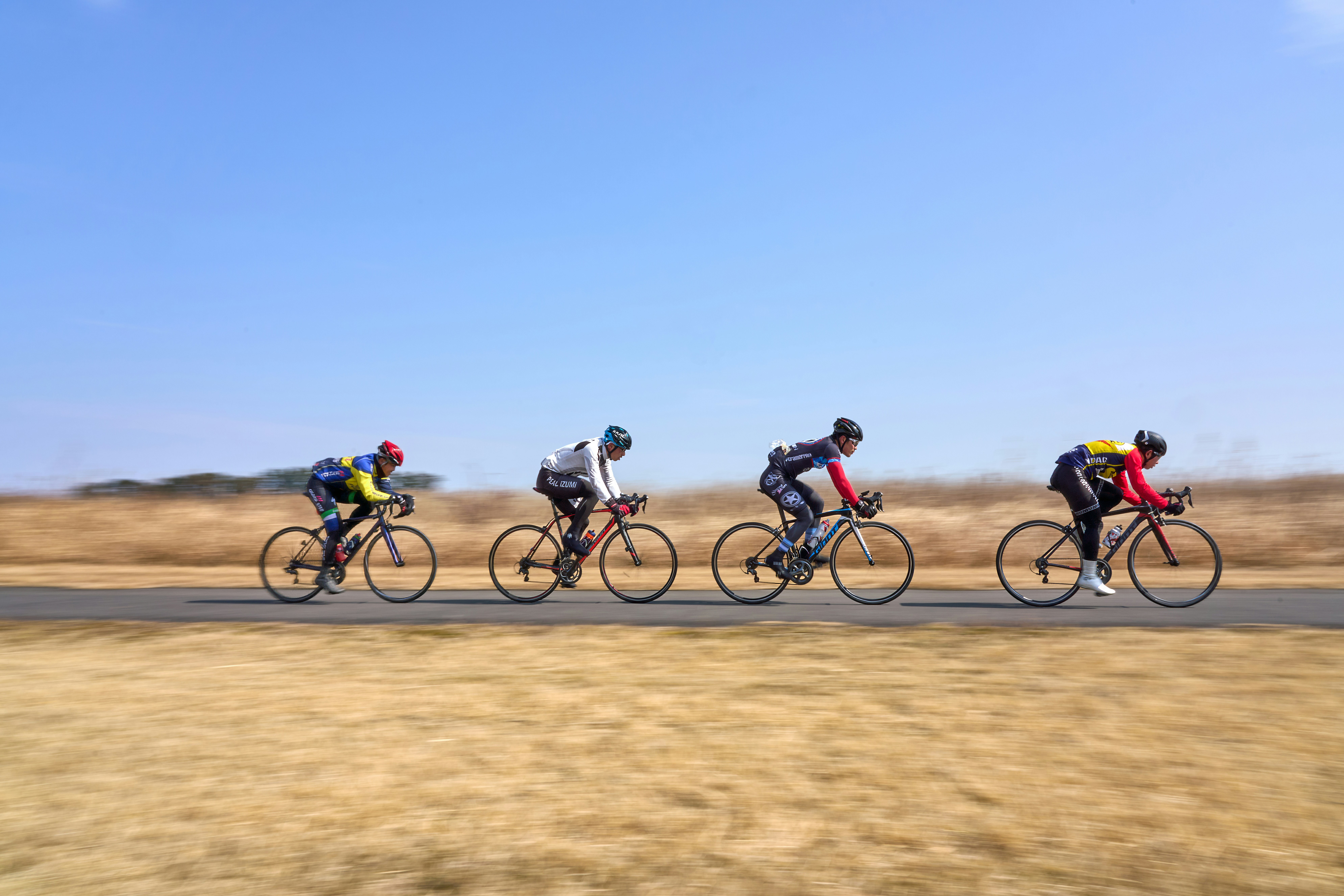 A group of people riding bikes down a road photo – Free Human Image on ...