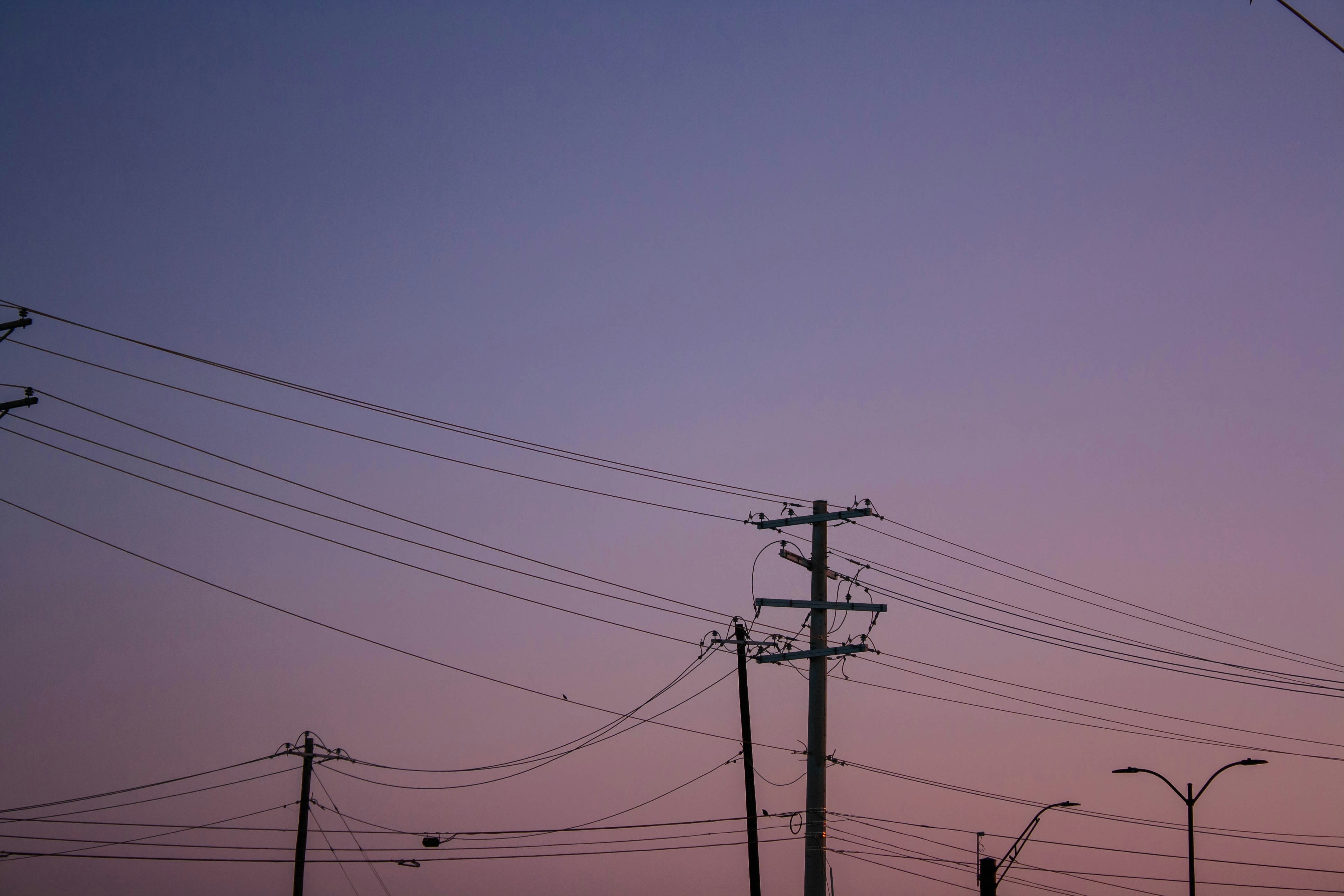 Power lines and telephone poles against a purple sky photo – Free ...