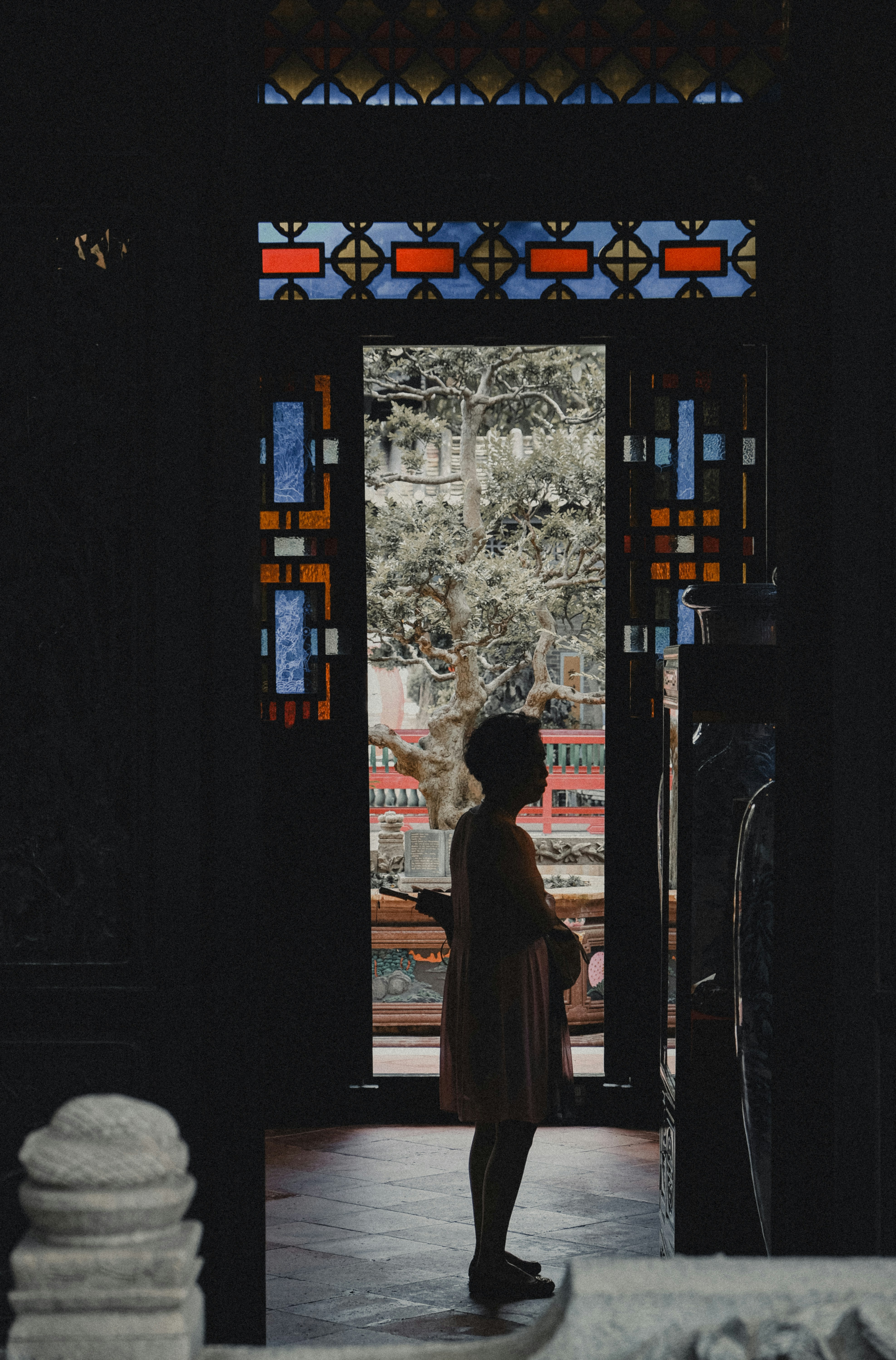 A woman standing in a doorway of a building photo – Free China Image on ...