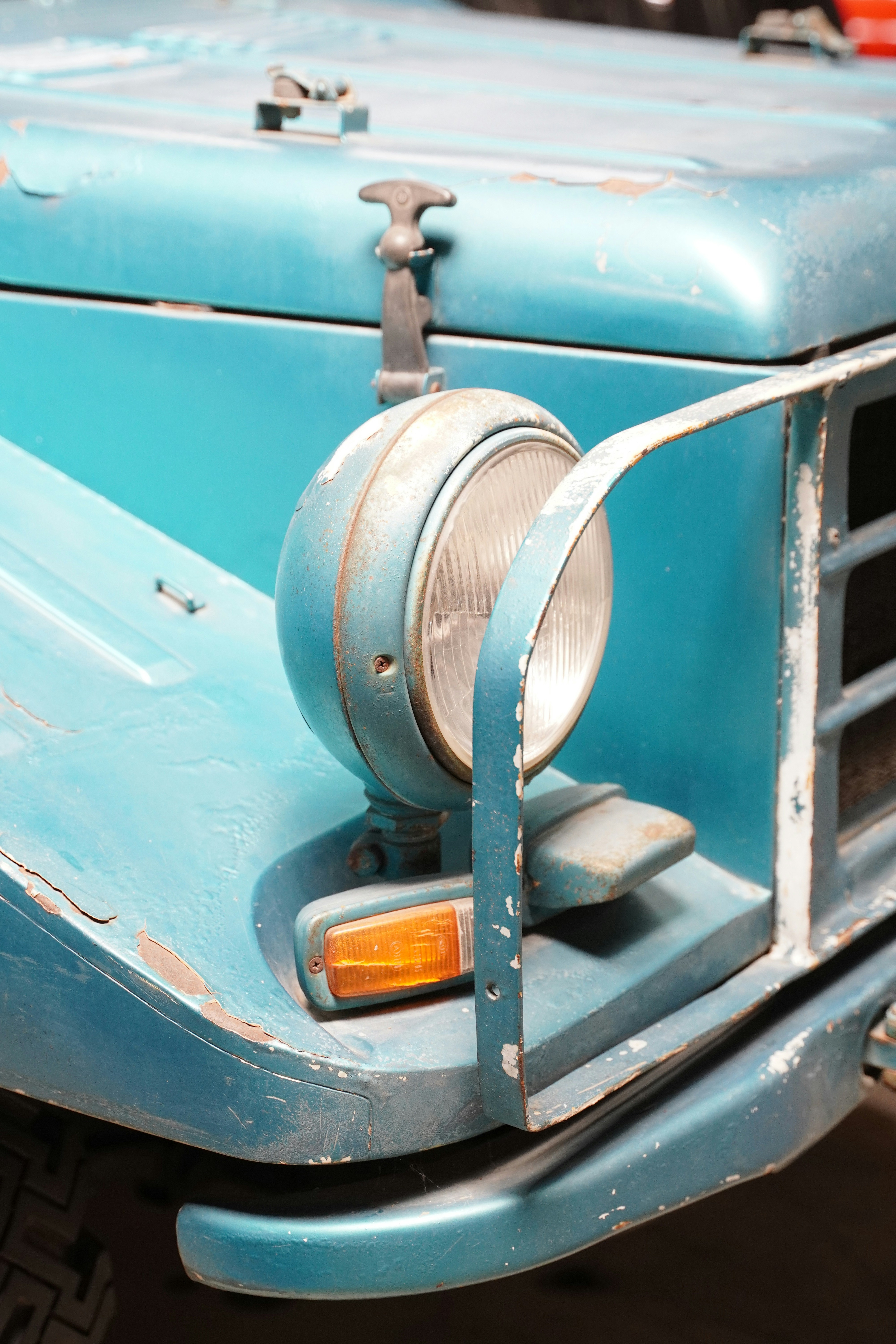 Patina on Teal Front: Close-Up of a Weathered Vintage Headlamp