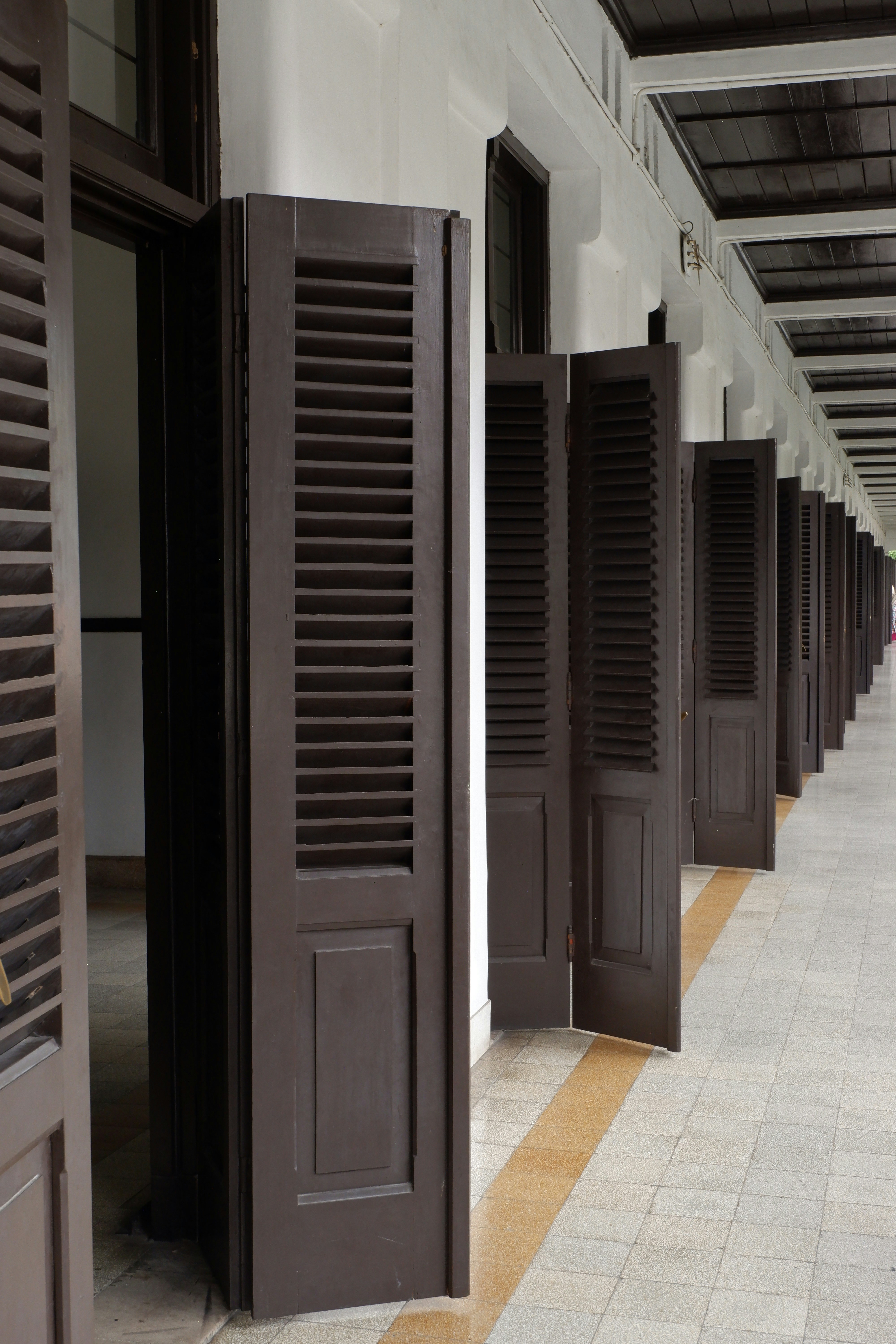 A row of brown shutters in a building photo – Free Floor Image on Unsplash