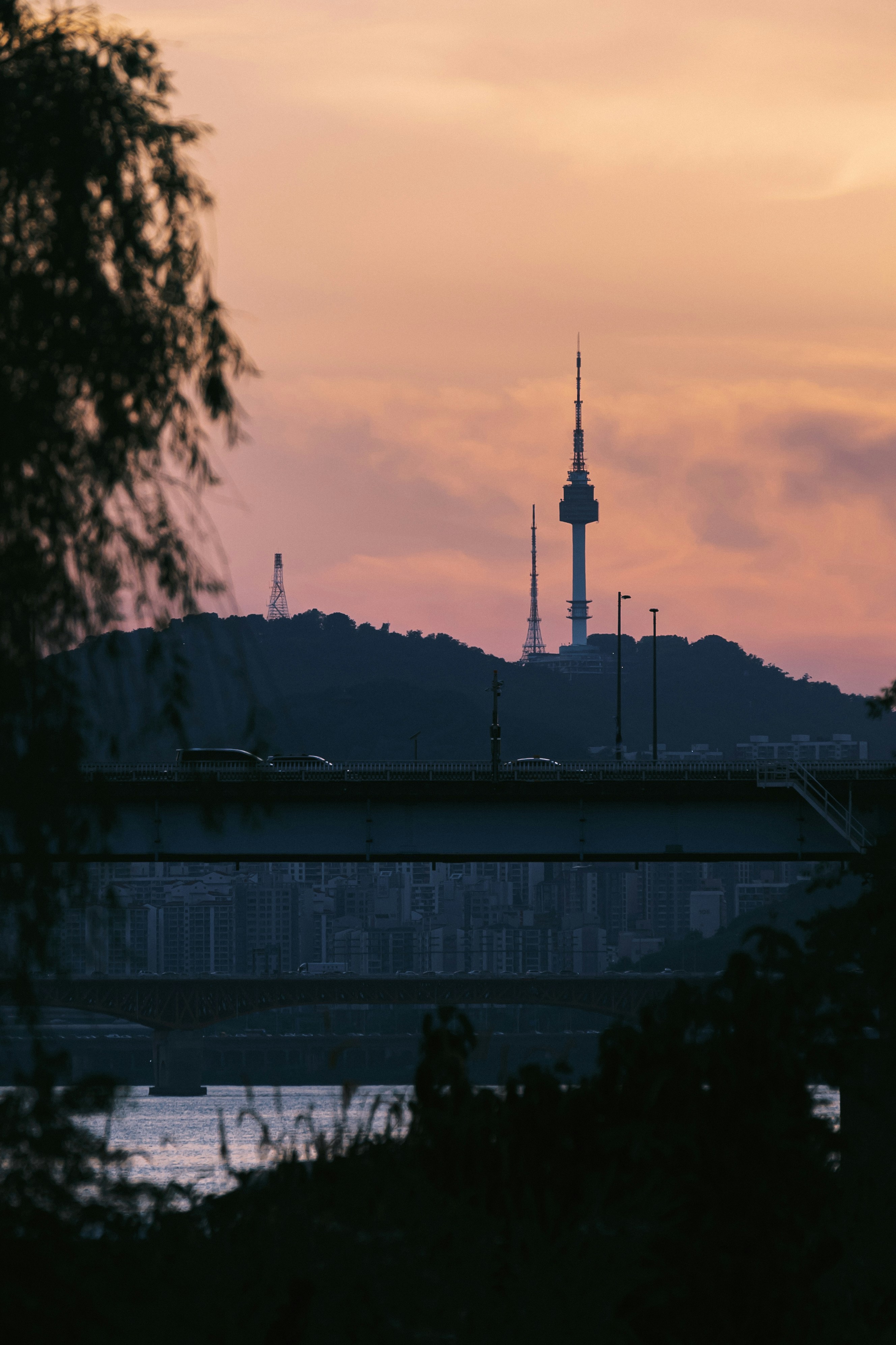 Dusk Sentinel: The Tower Silhouette Over a Quiet River