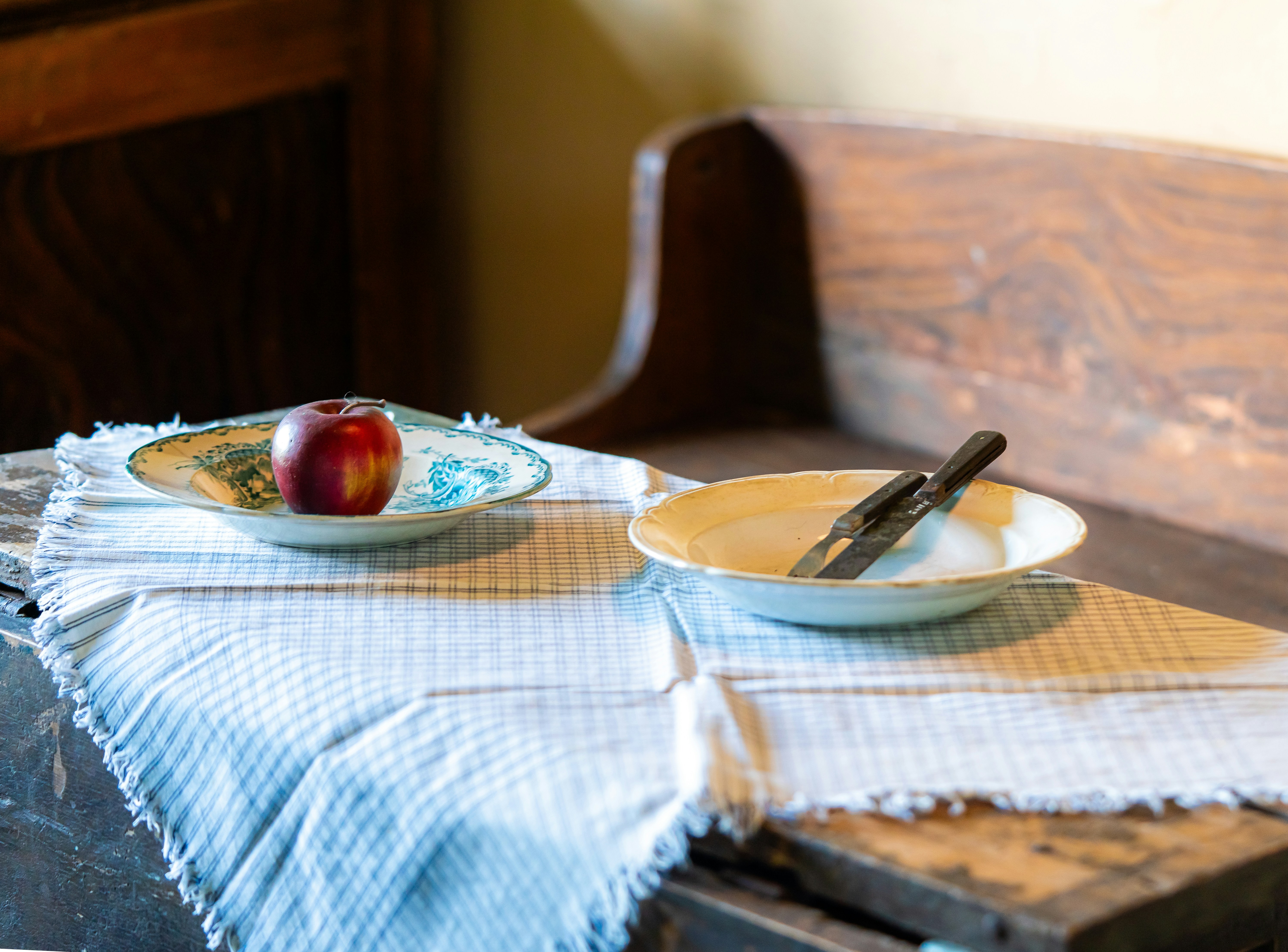 Apple on Frayed Linen: A Quiet Still-Life on a Weathered Wooden Table