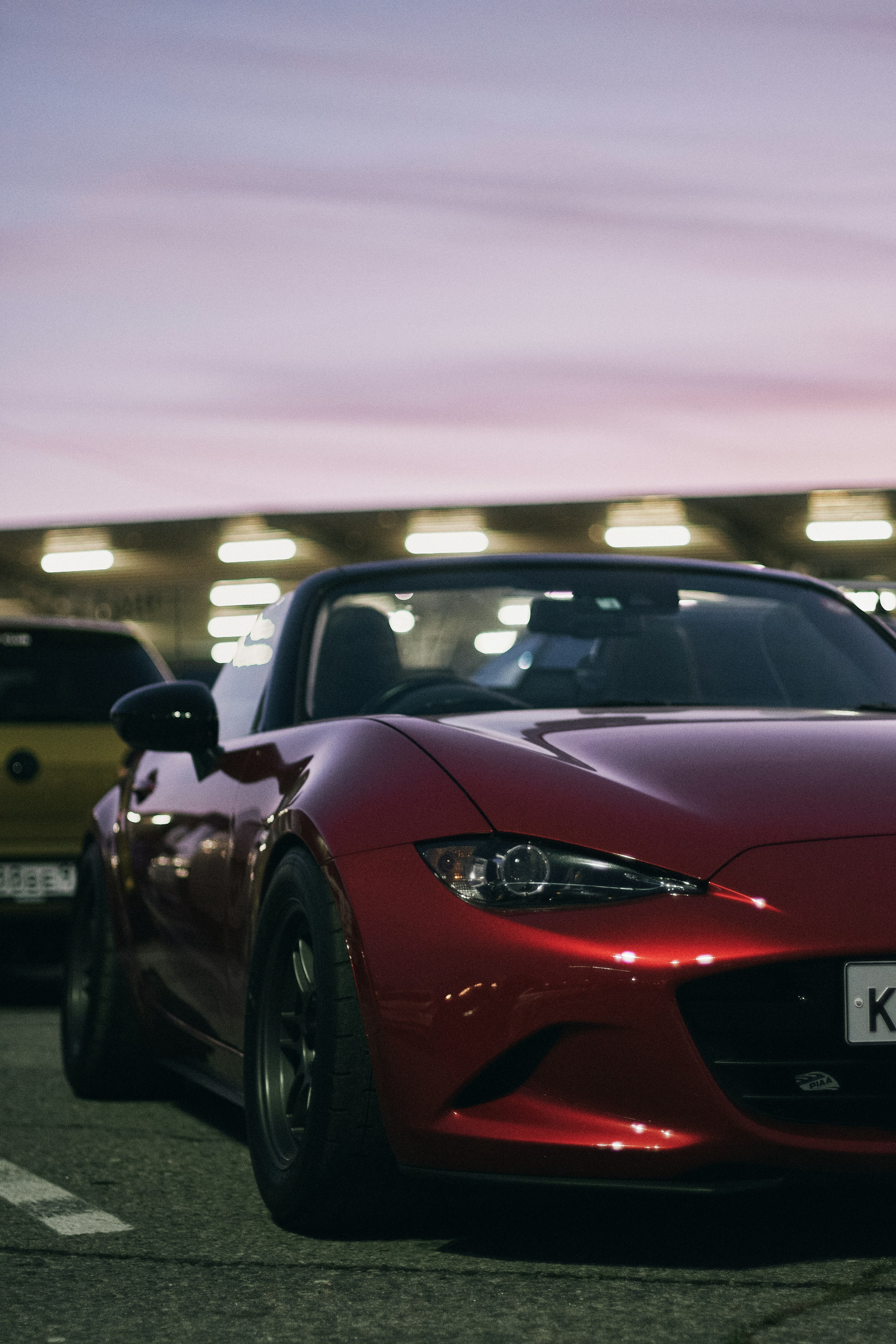 Red Roadster Under Neon Skies