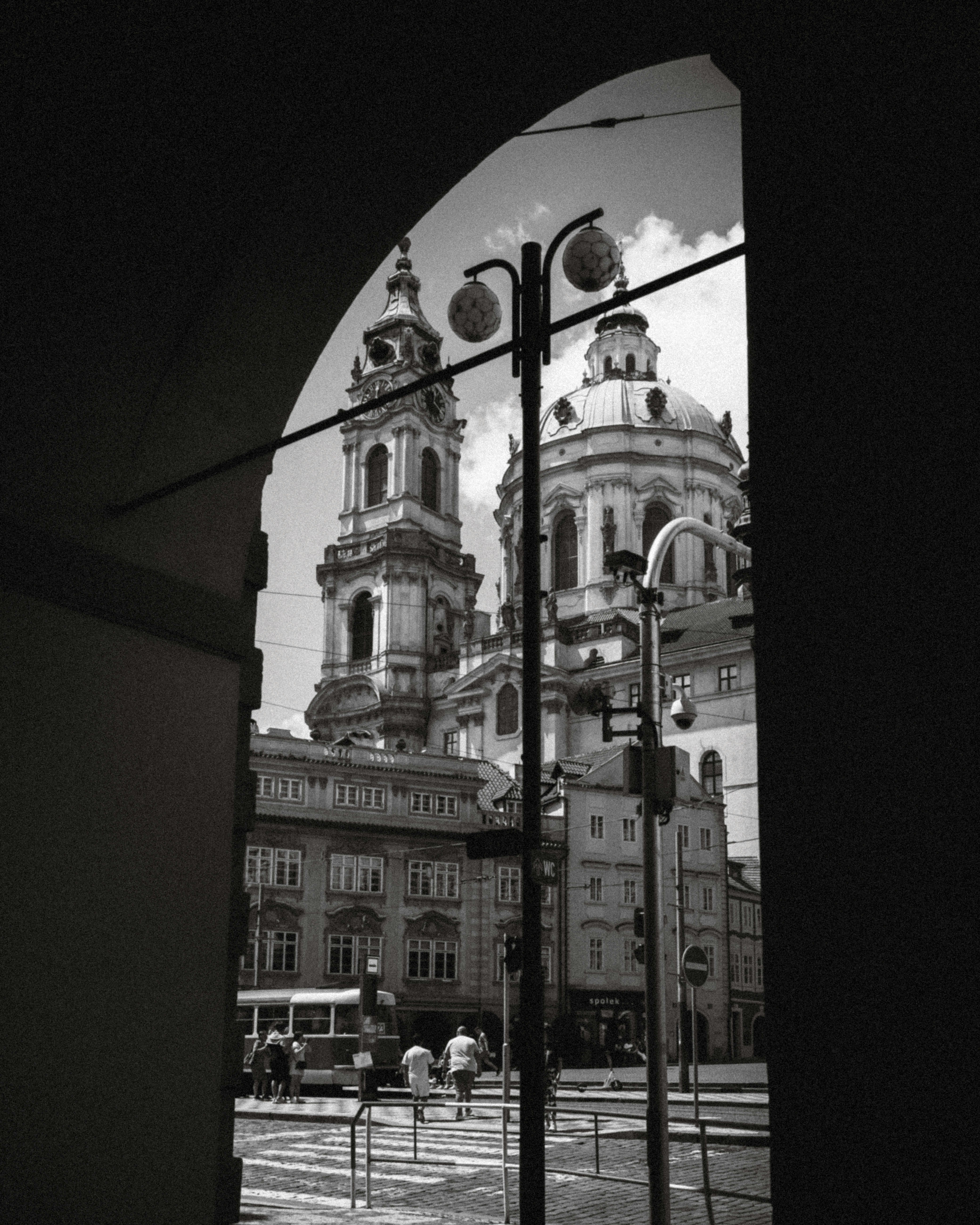 A black and white photo of a building through a window