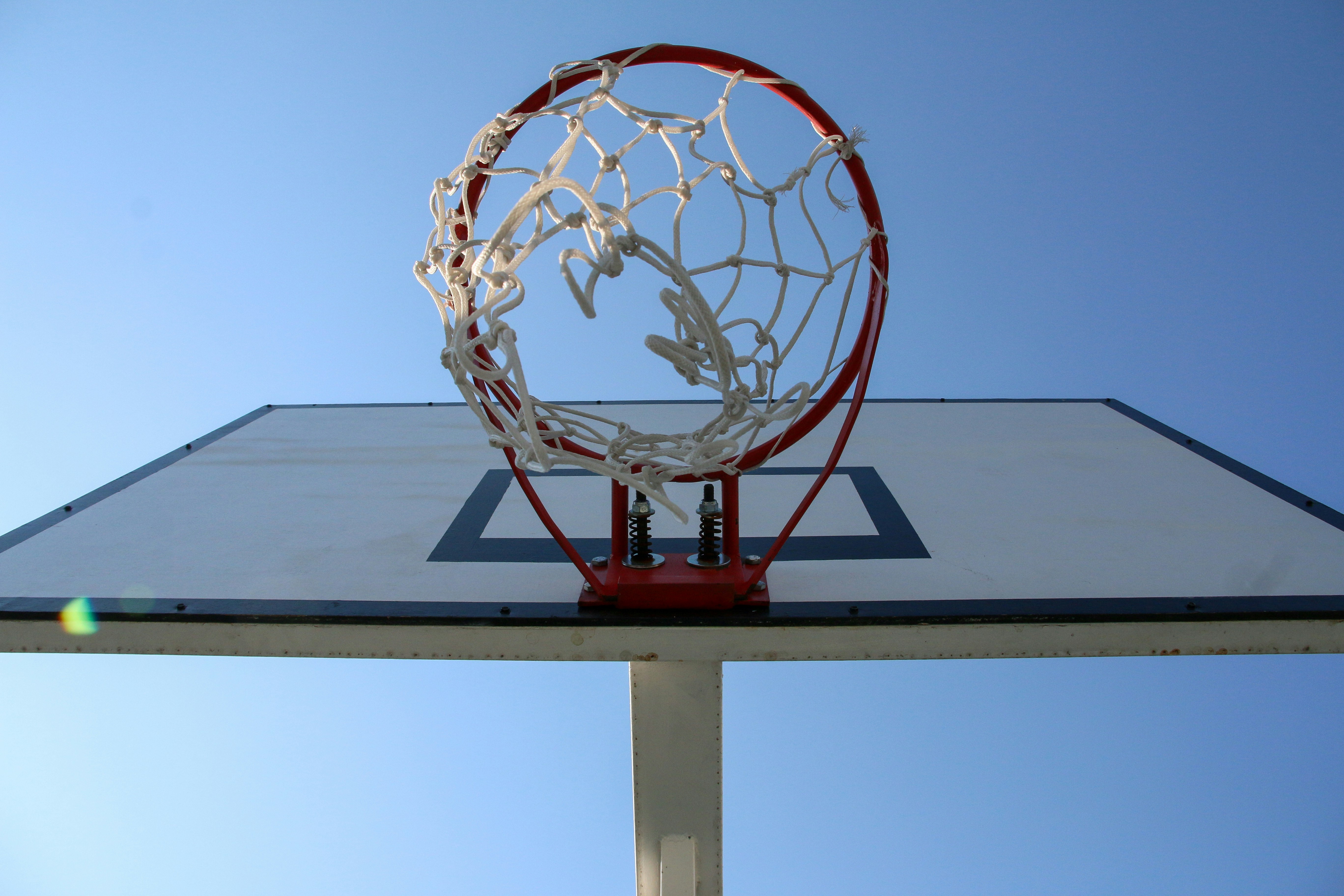 A basketball hoop with a basketball inside of it photo – Free ...