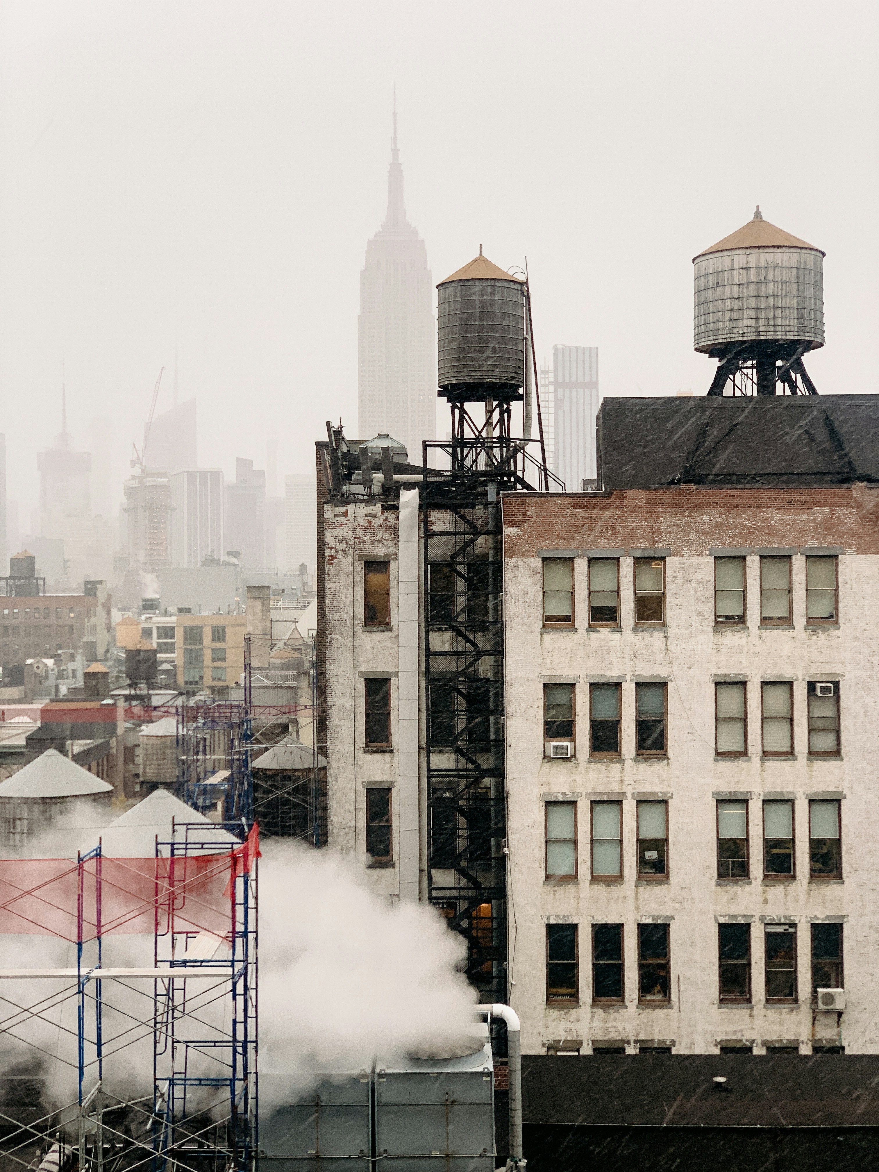 Rooftop Steam and Water Towers in a Fogged Cityscape