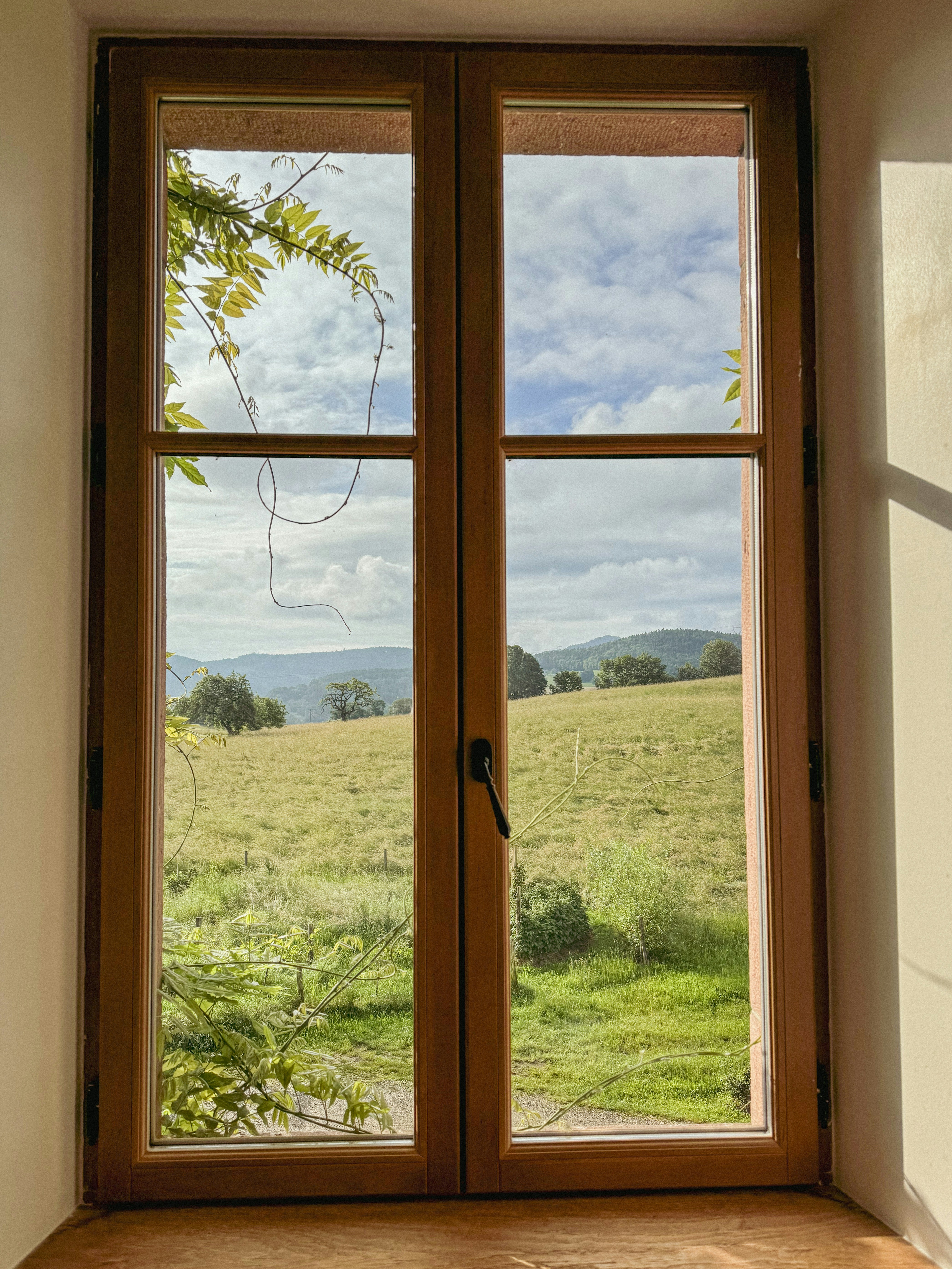 A window with a view of a grassy field photo – Free French window Image ...