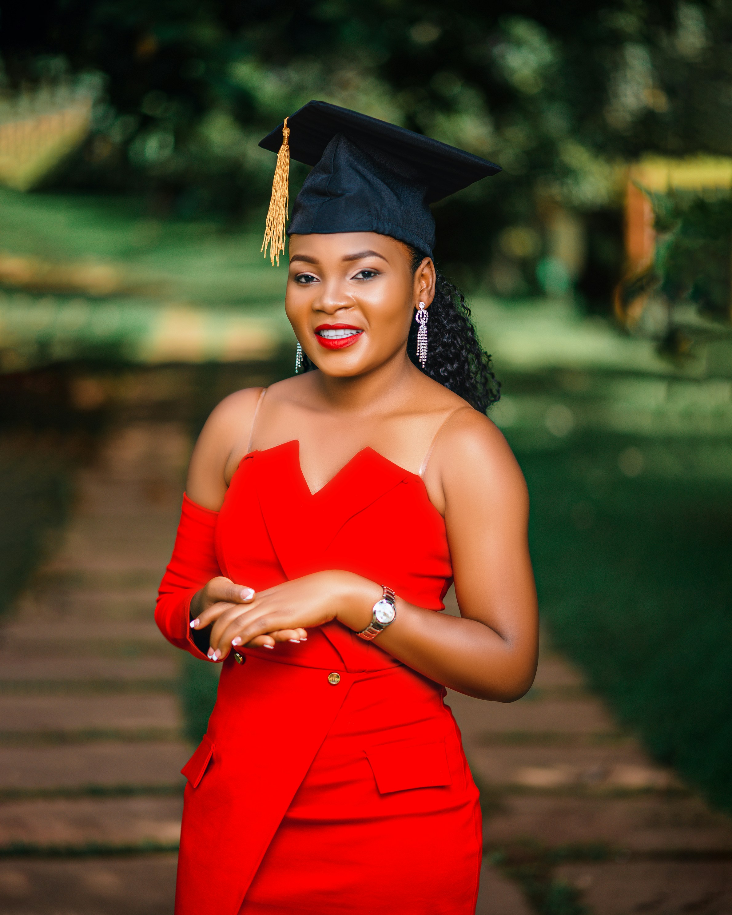 A woman wearing a red dress and a graduation cap photo – Free Uganda ...