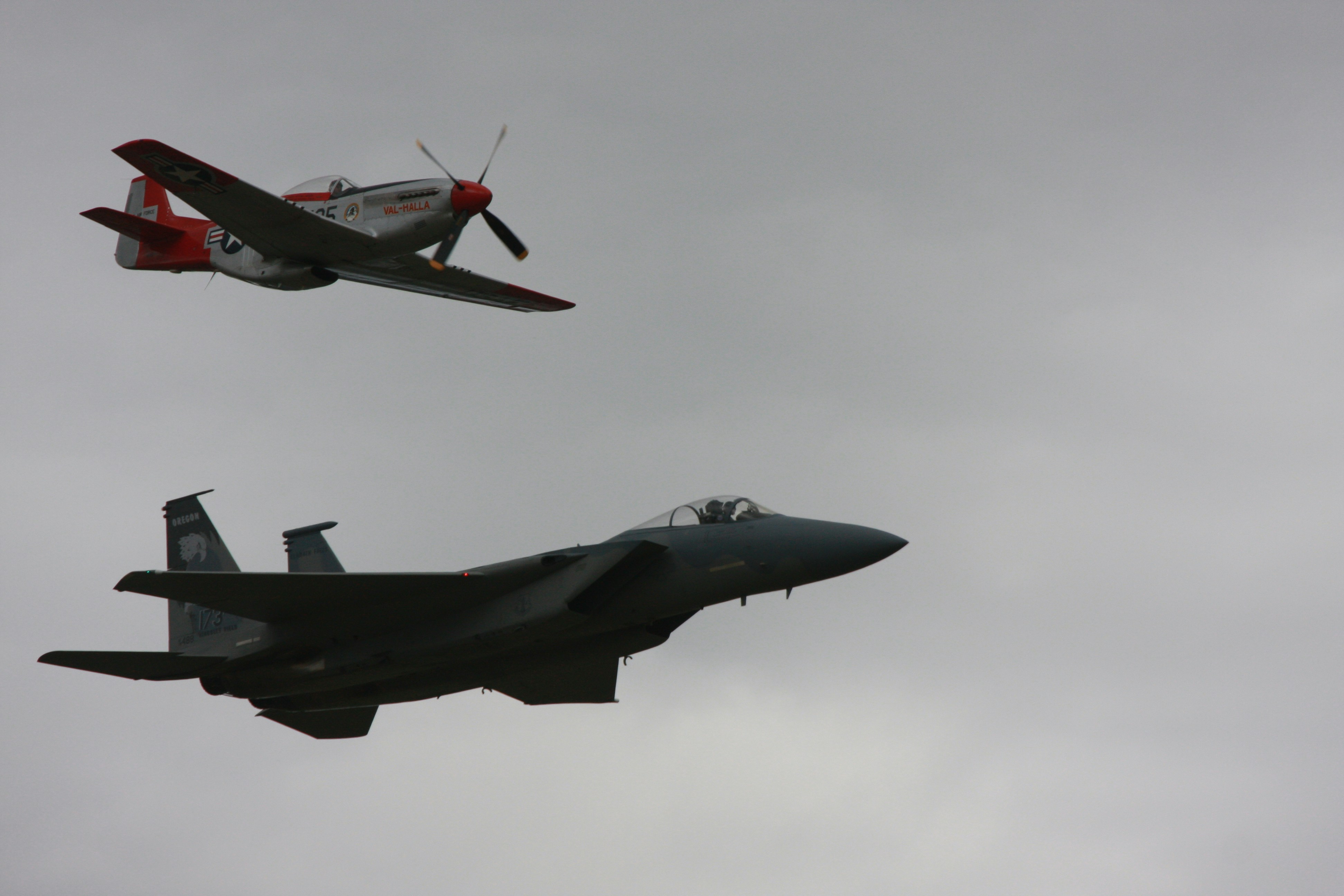 A couple of fighter jets flying through a cloudy sky photo – Free ...
