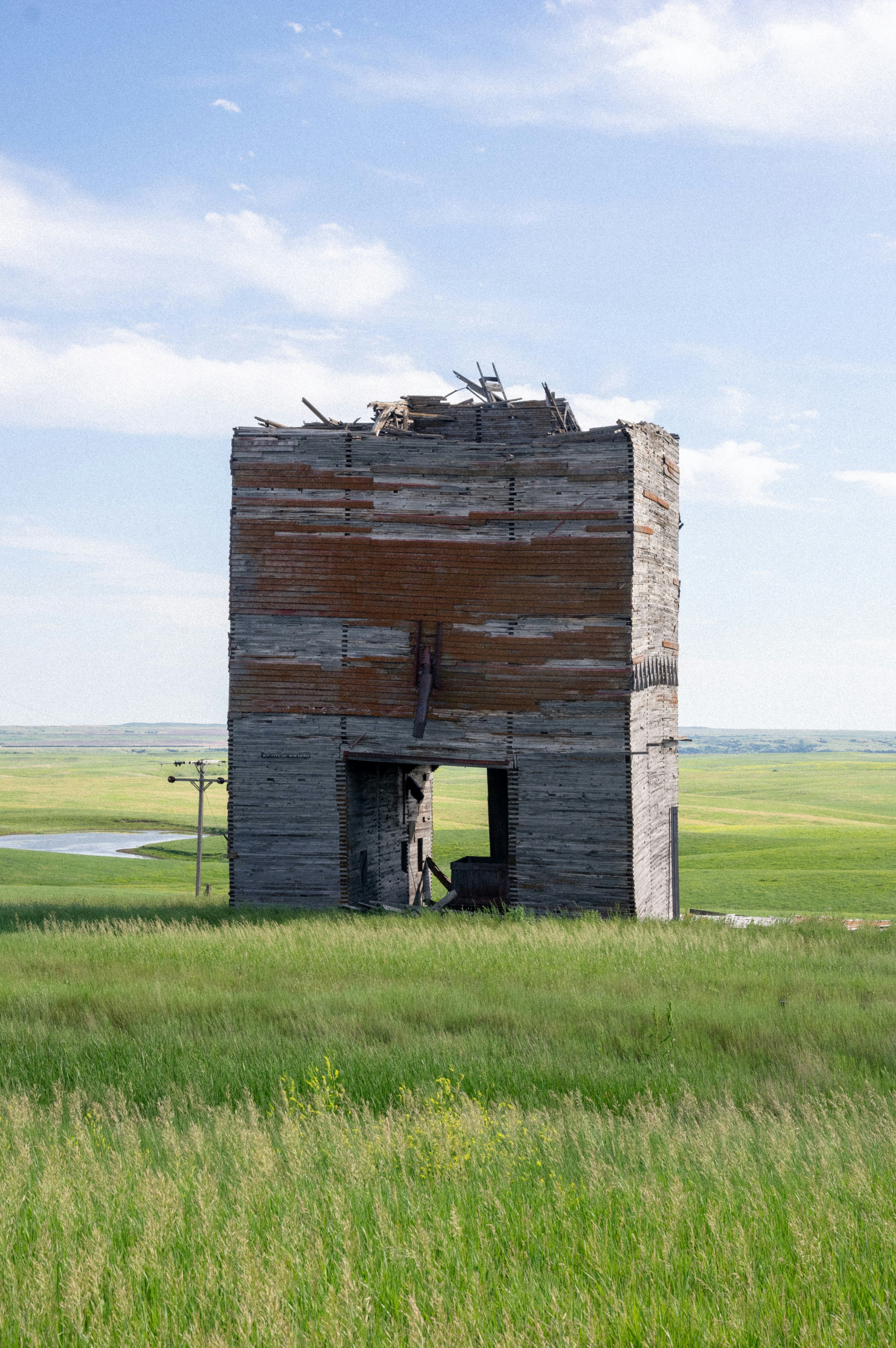 Deserted Grain Elevator Standing Sentinel Over Prairie