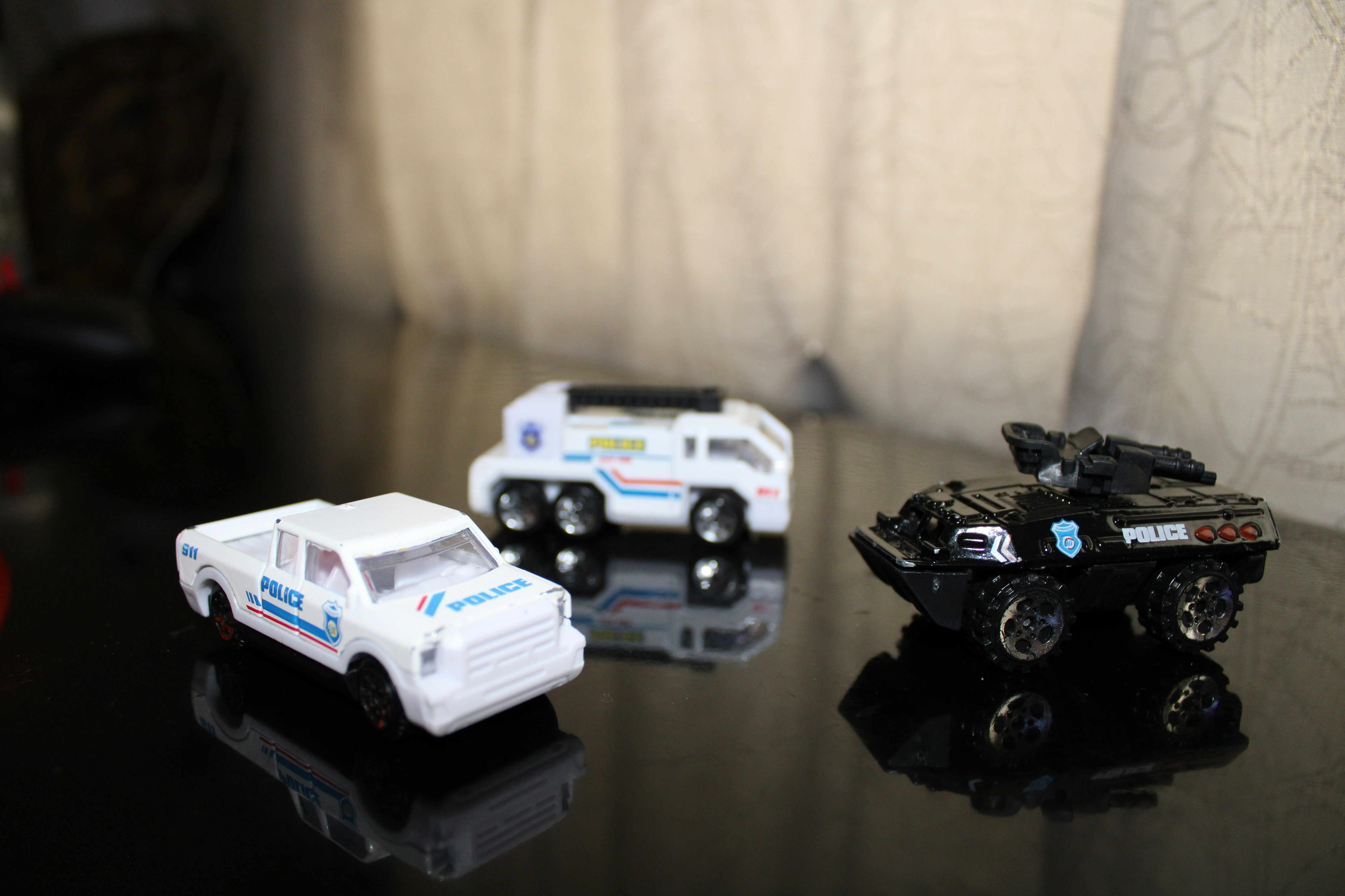 Tiny Police Fleet: Toys on a Shimmering Desk