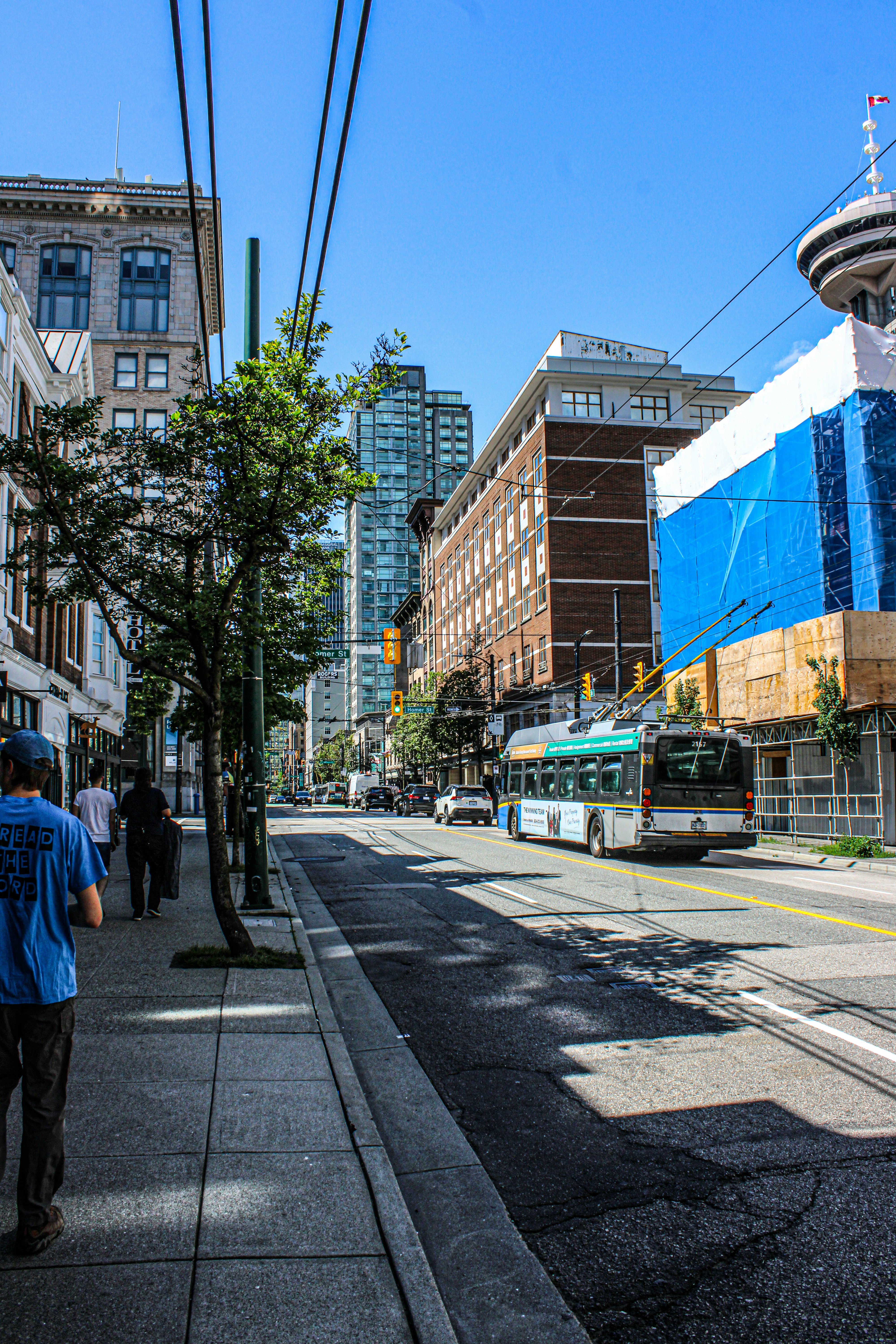Sunlit Downtown Tram Drift Along a Busy Street