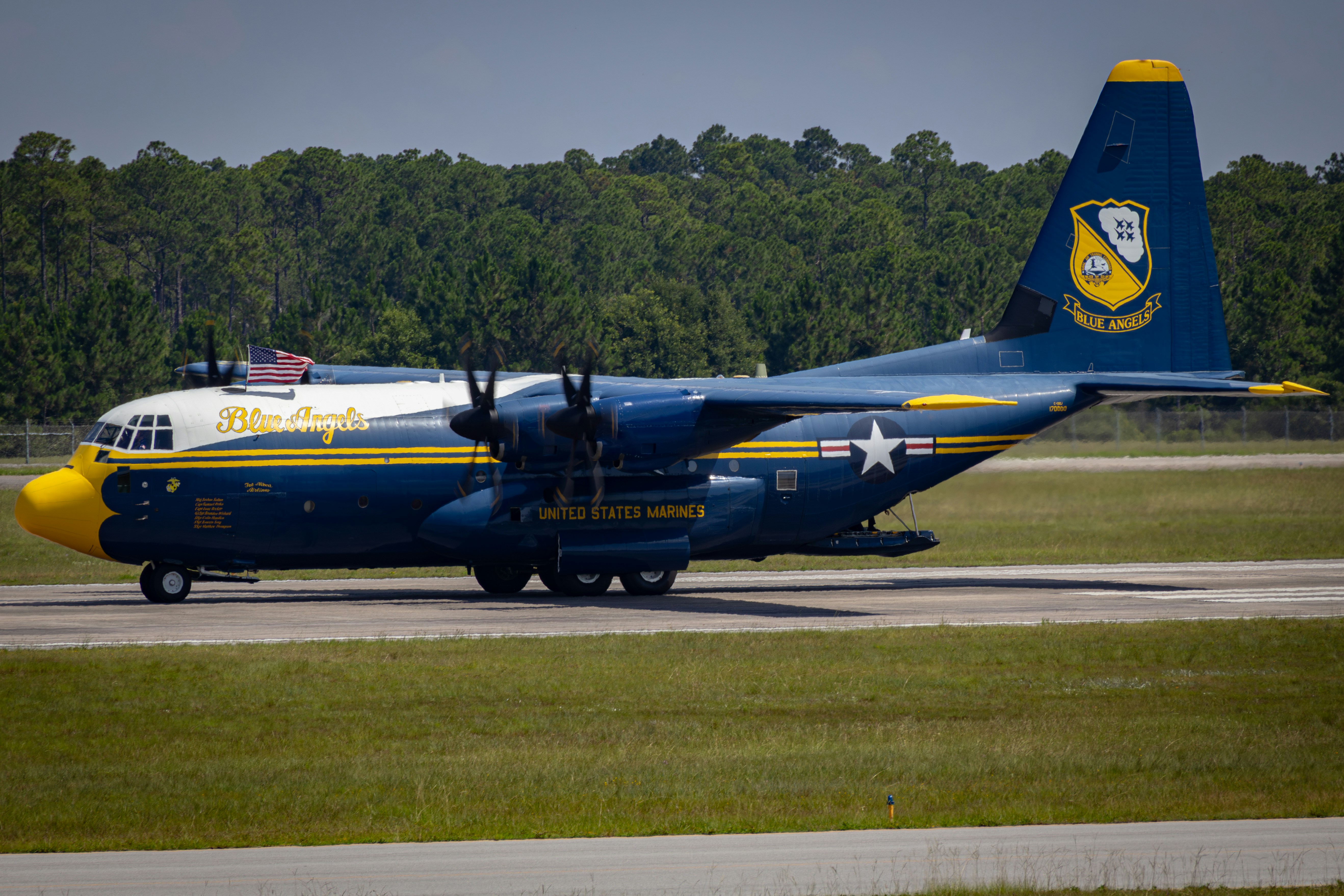 A blue and yellow airplane is on the runway photo – Free Airfield Image ...