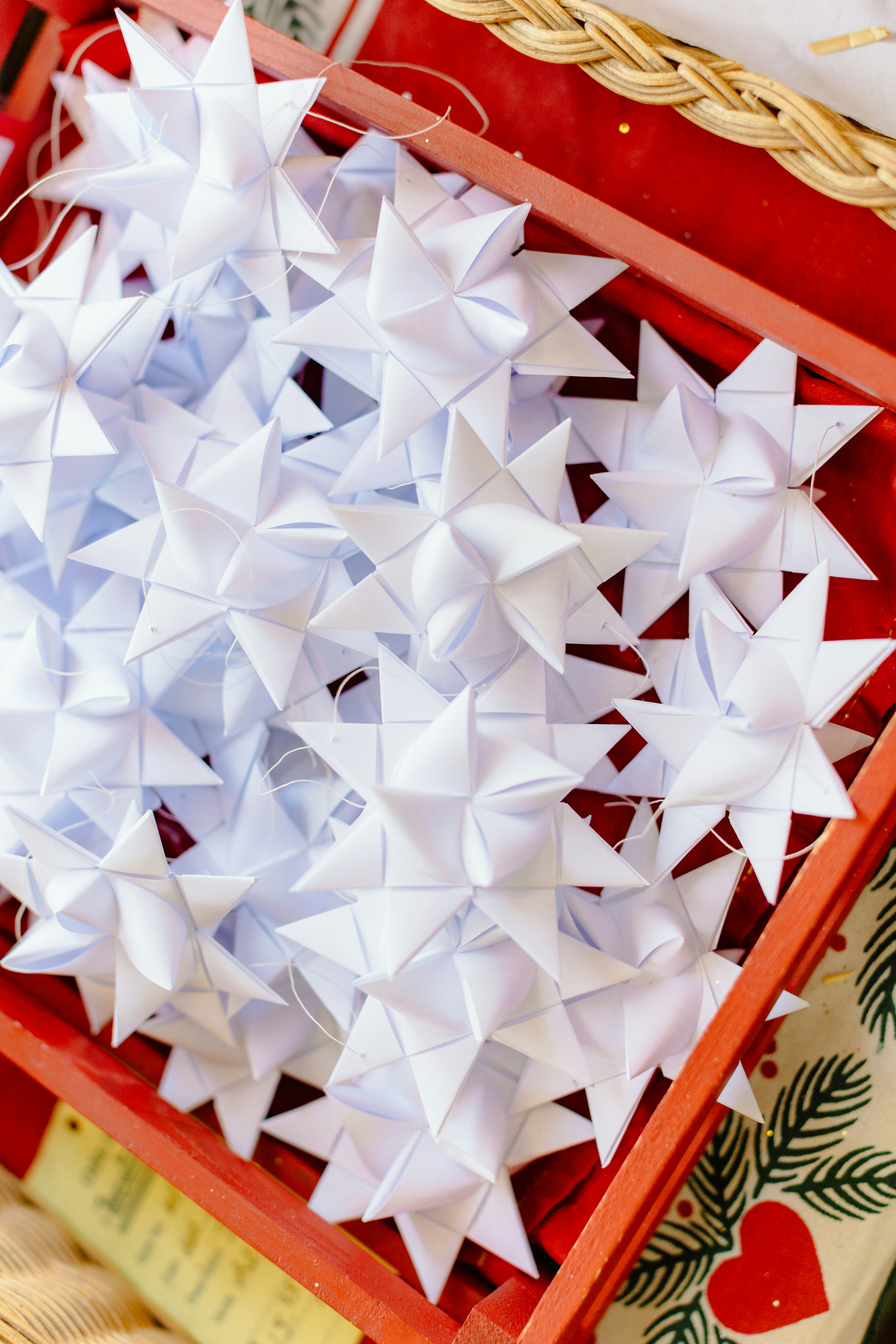 Crystalline Origami Stars Overflowing from a Red Crate